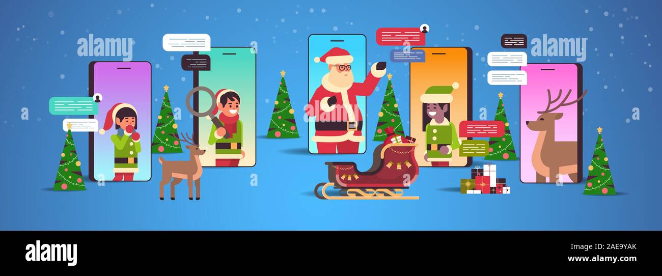 santa claus with elves helpers using chatting app social network ...