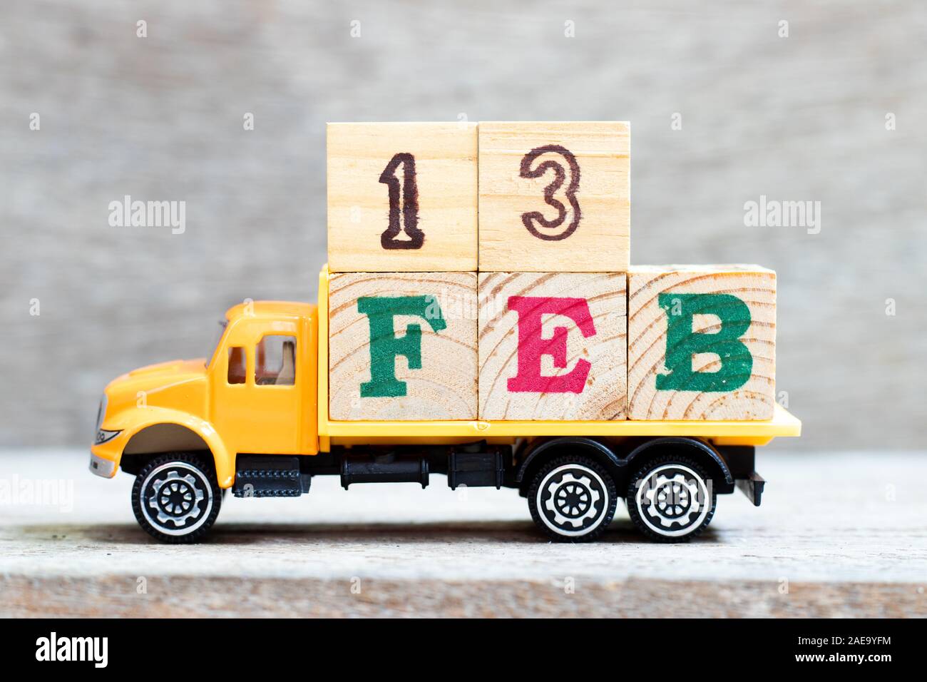 Truck hold letter block in word 13feb on wood background (Concept for ...