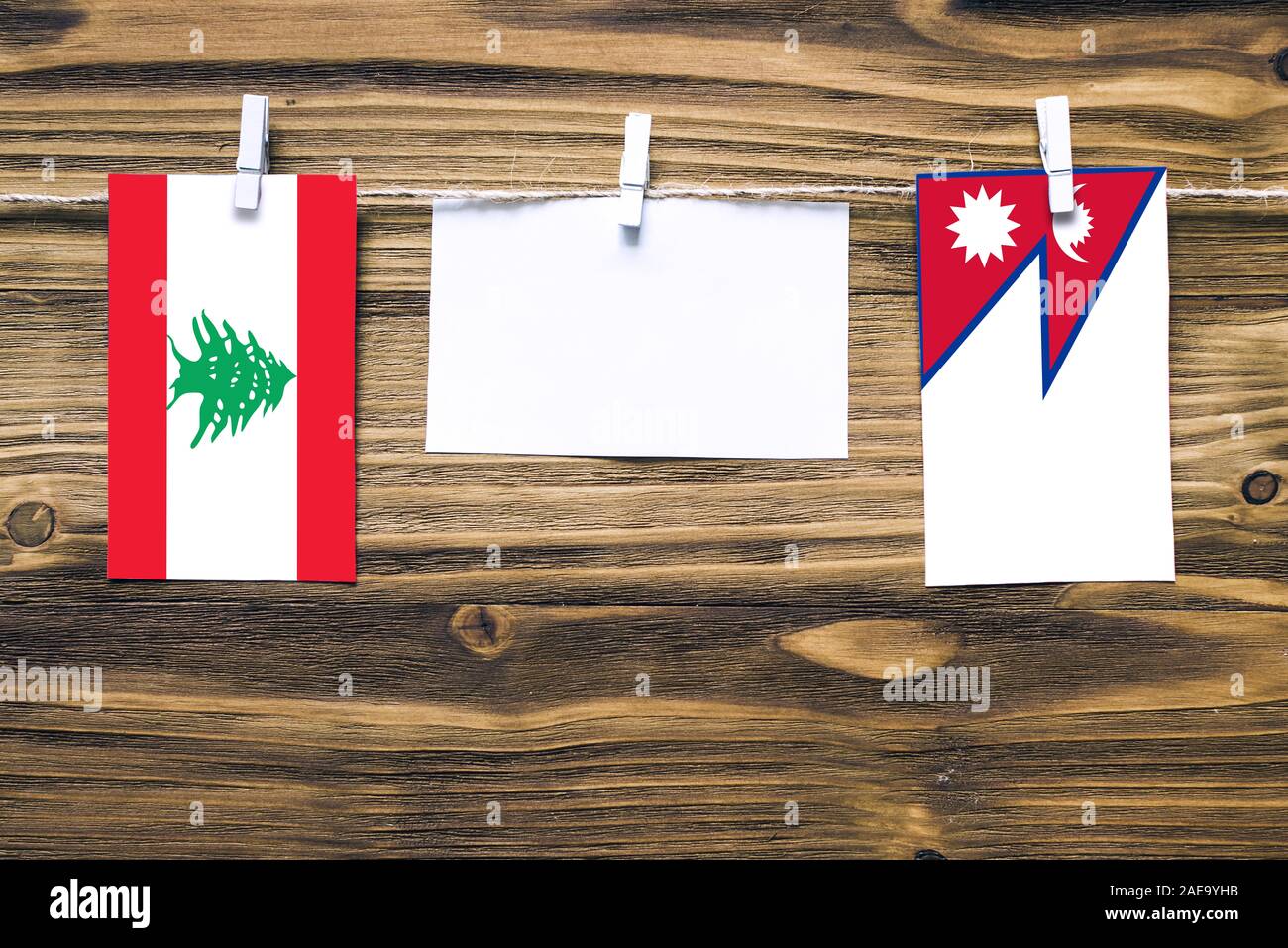 Hanging flags of Lebanon and Nepal attached to rope with clothes pins ...