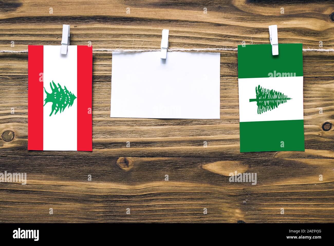 Hanging flags of Lebanon and Norfolk Island attached to rope with ...