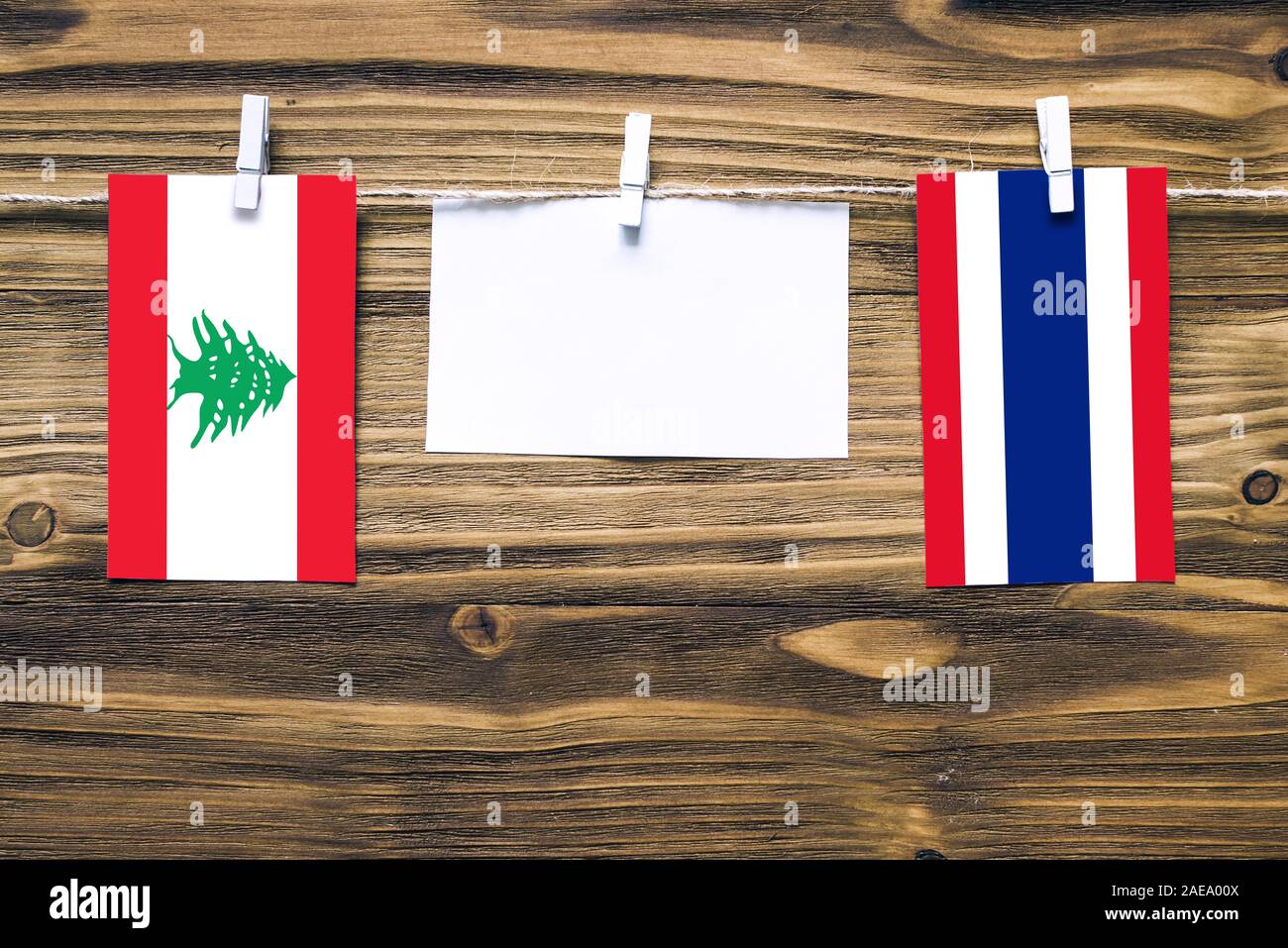 Hanging flags of Lebanon and Thailand attached to rope with clothes ...