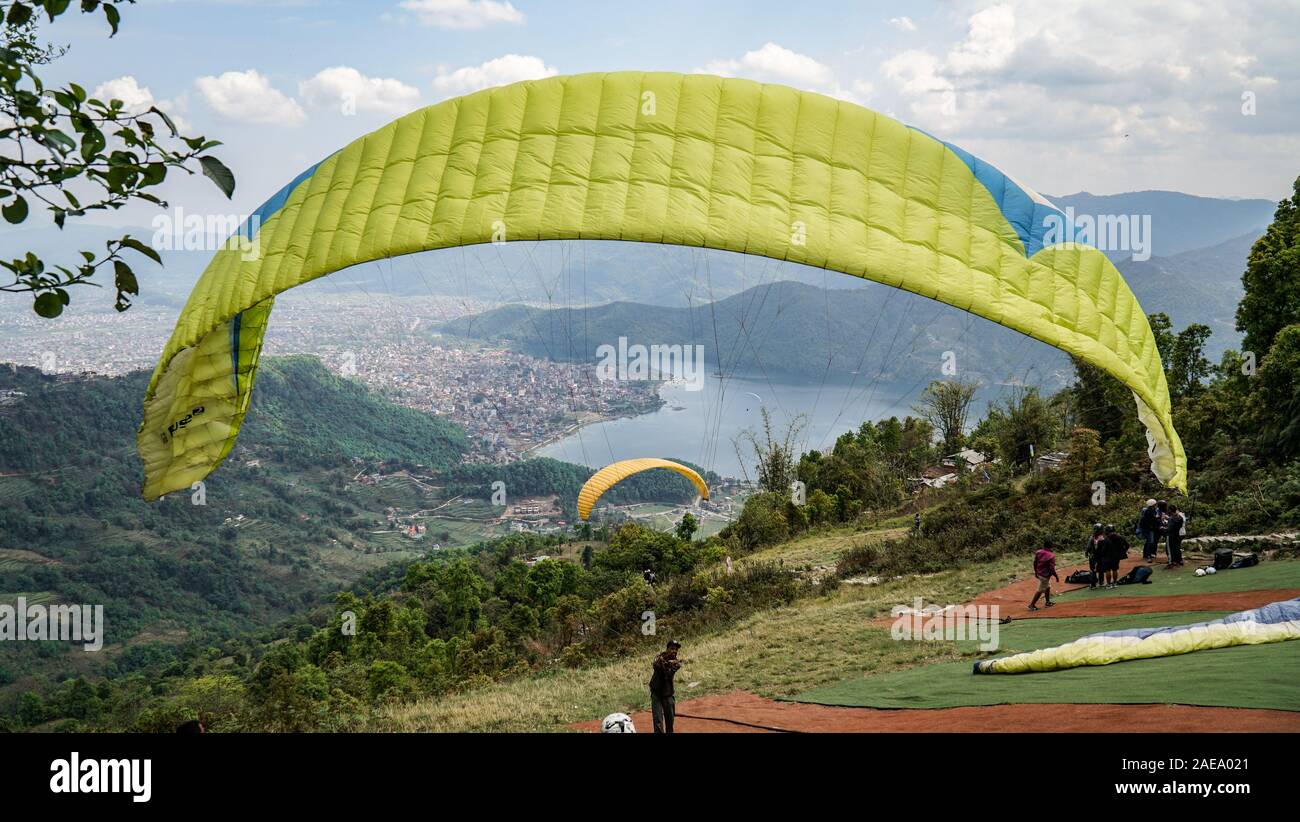 Paragliders flying against the Himalayas , Pokhara , Nepal Stock Photo ...