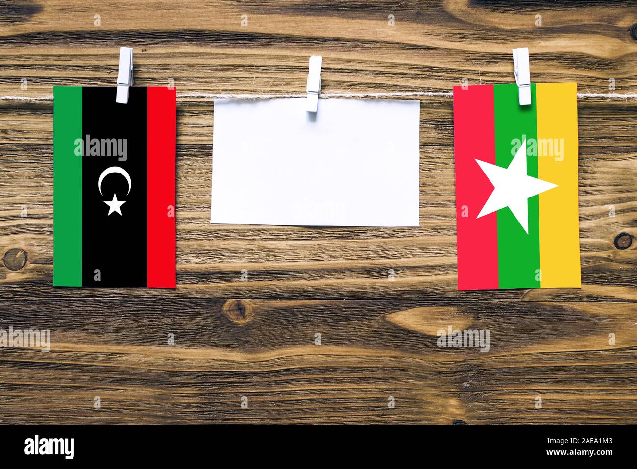 Hanging flags of Libya and Myanmar attached to rope with clothes pins ...