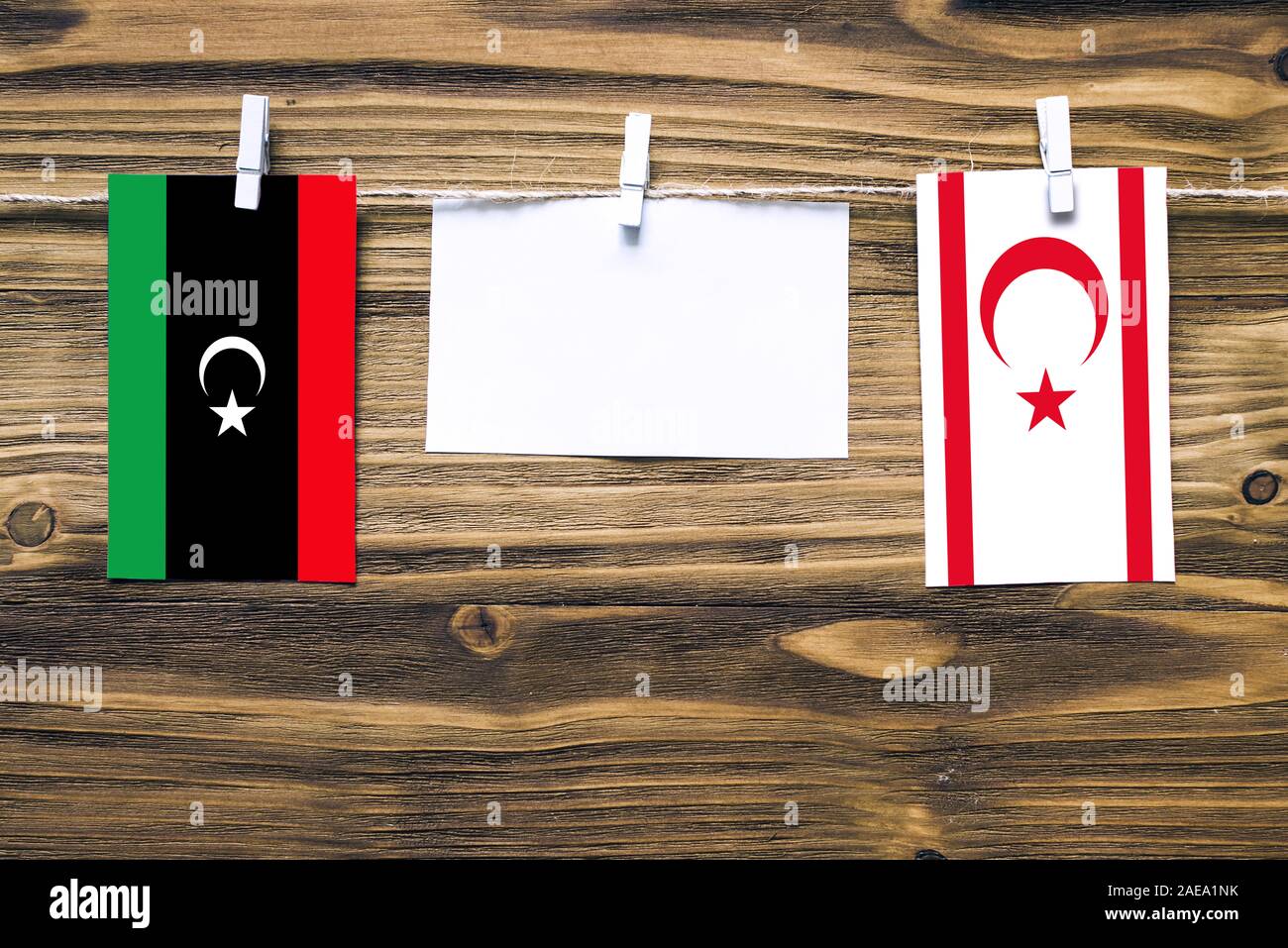 Hanging flags of Libya and Northern Cyprus attached to rope with ...