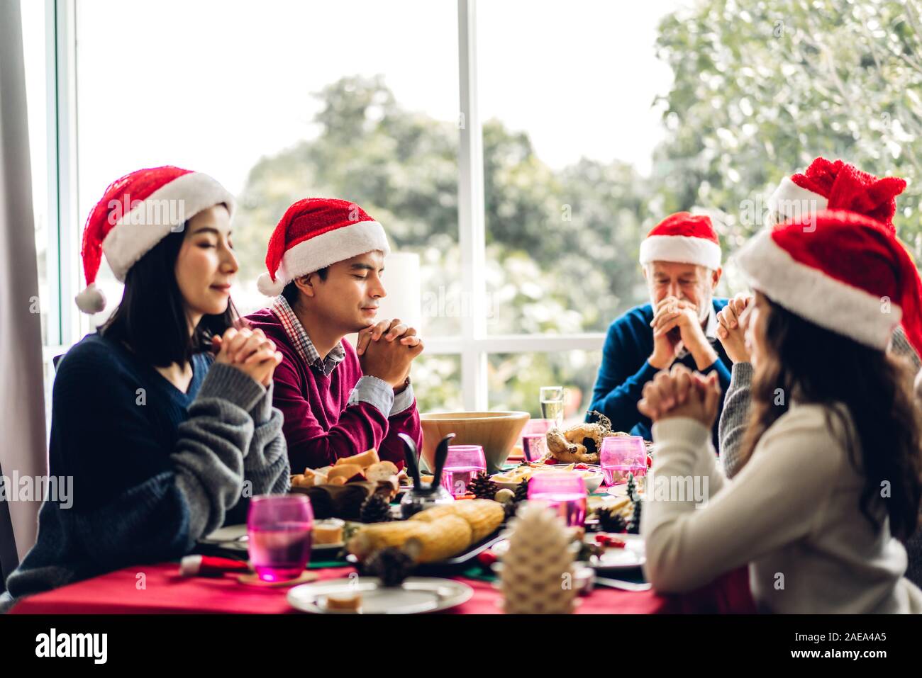 Portrait of happy big family celebrating santa hats having fun and ...