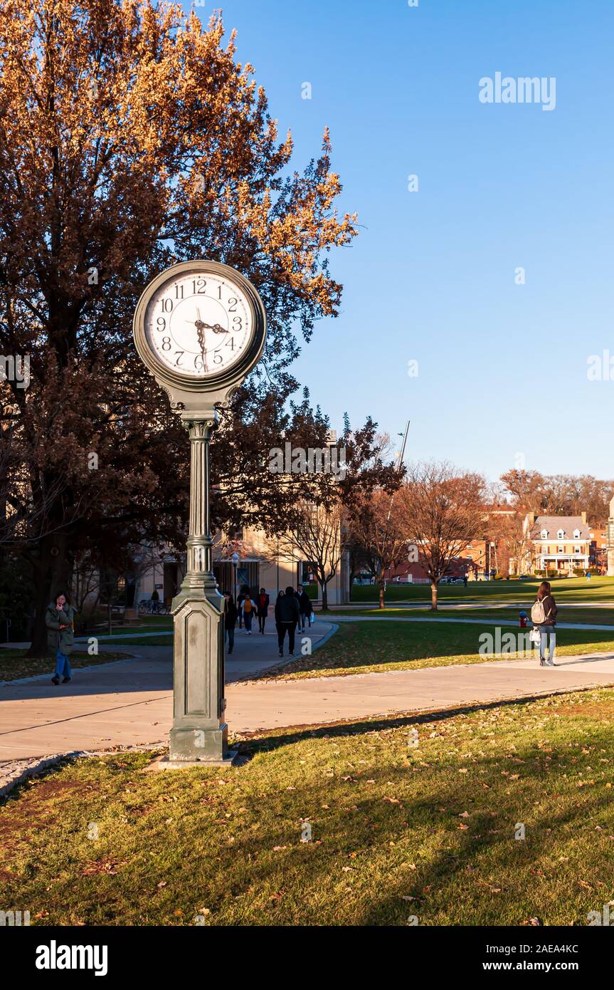 A clock on the campus of Carnegie Mellon University with students ...