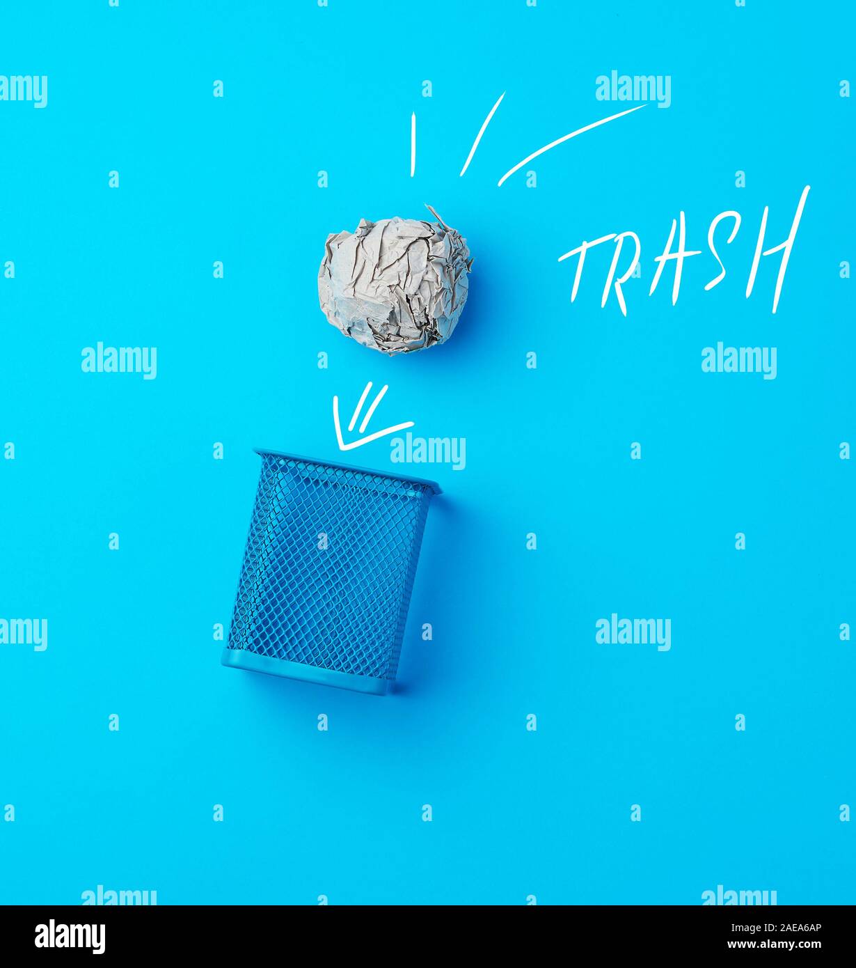 ball of crumpled gray paper and metal blue wastebasket, concept of ...