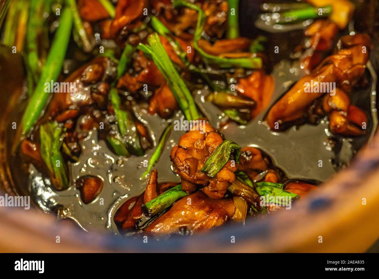 Closeup photo of Singapore style frog porridge with spring onion Stock ...