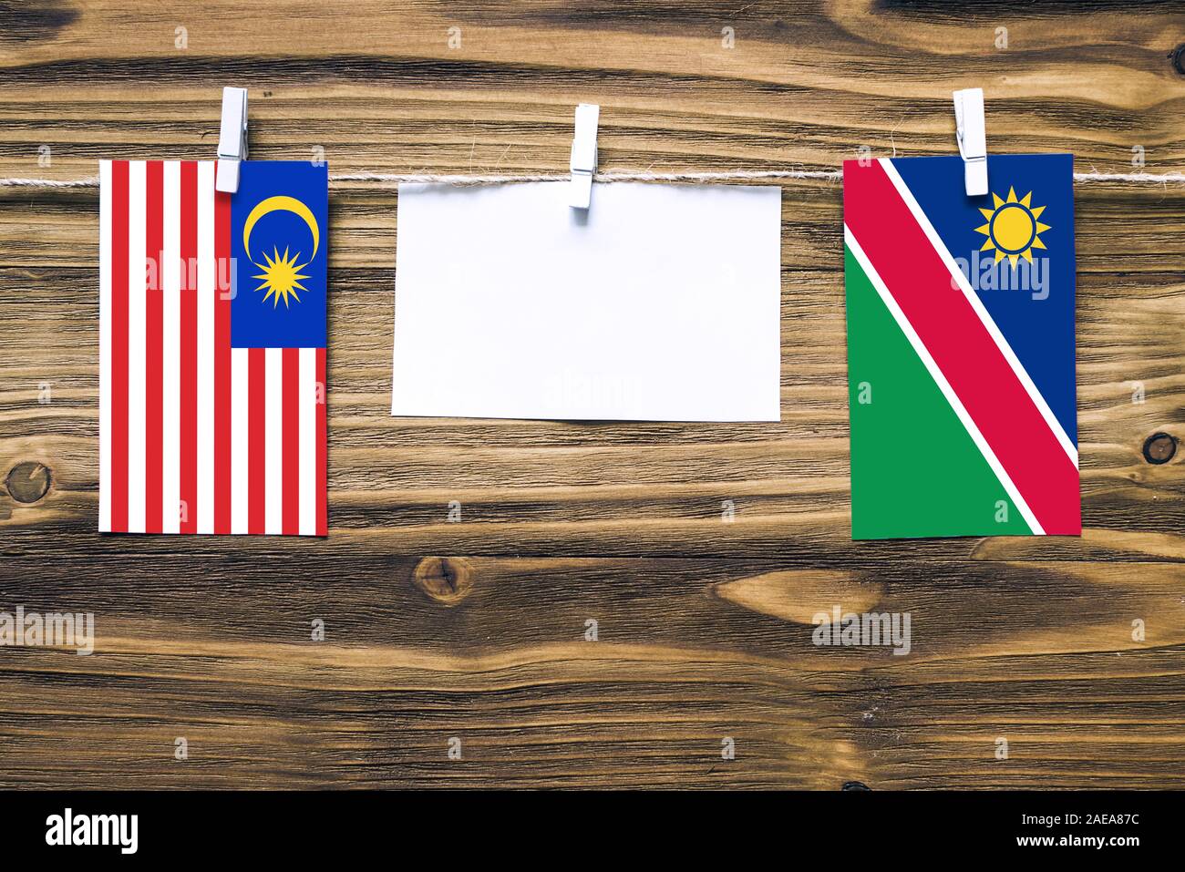 Hanging flags of Malaysia and Namibia attached to rope with clothes ...