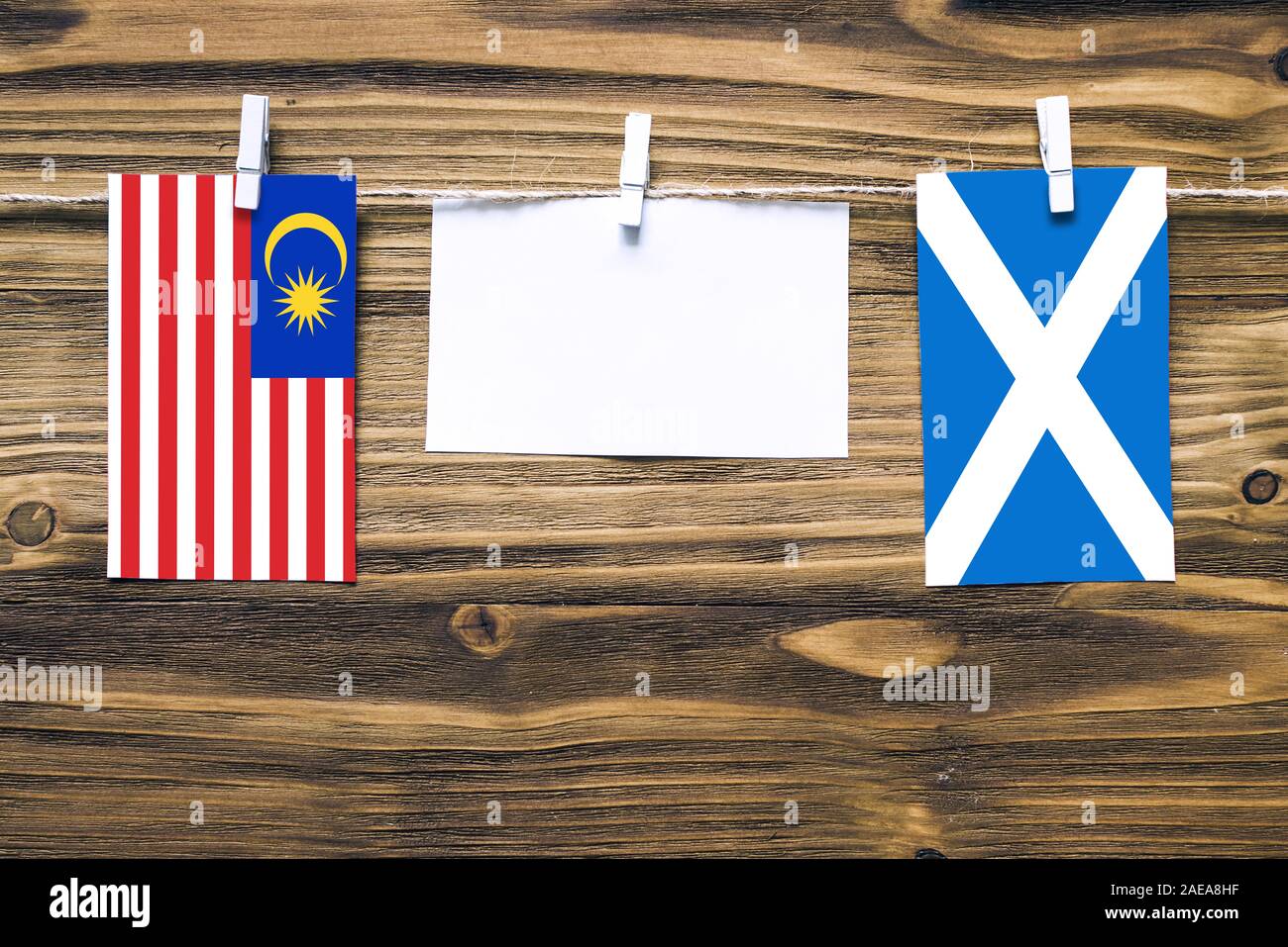 Hanging flags of Malaysia and Scotland attached to rope with clothes ...
