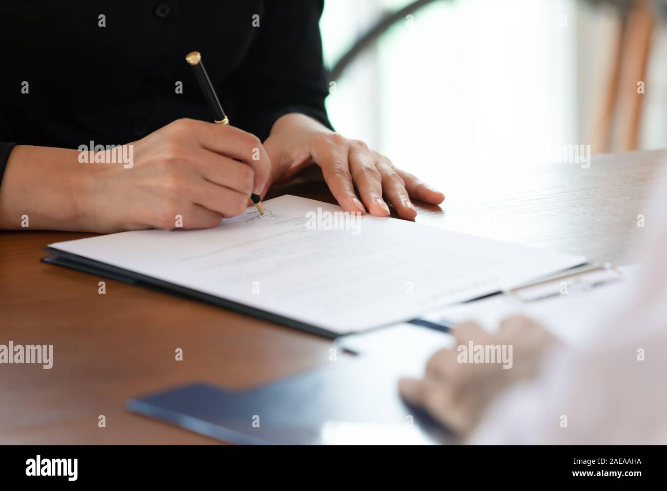 Close up cropped image young woman signing business agreement Stock ...