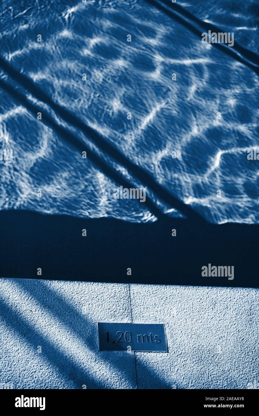 Outdoor Swimming pool with sunlight and shadows. Color of the year 2020 ...