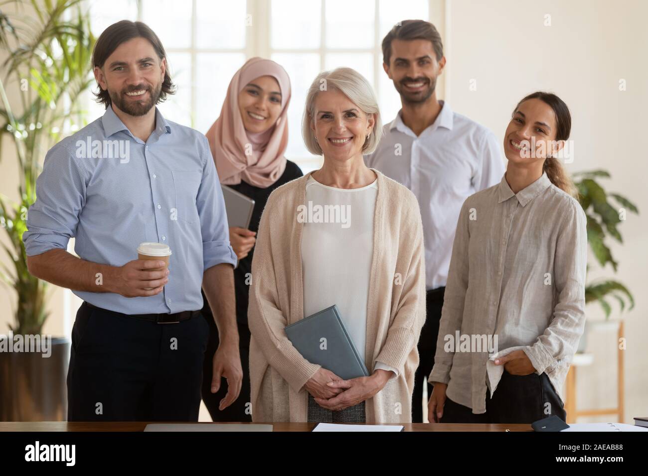 Happy successful international team of professionals posing for photo ...