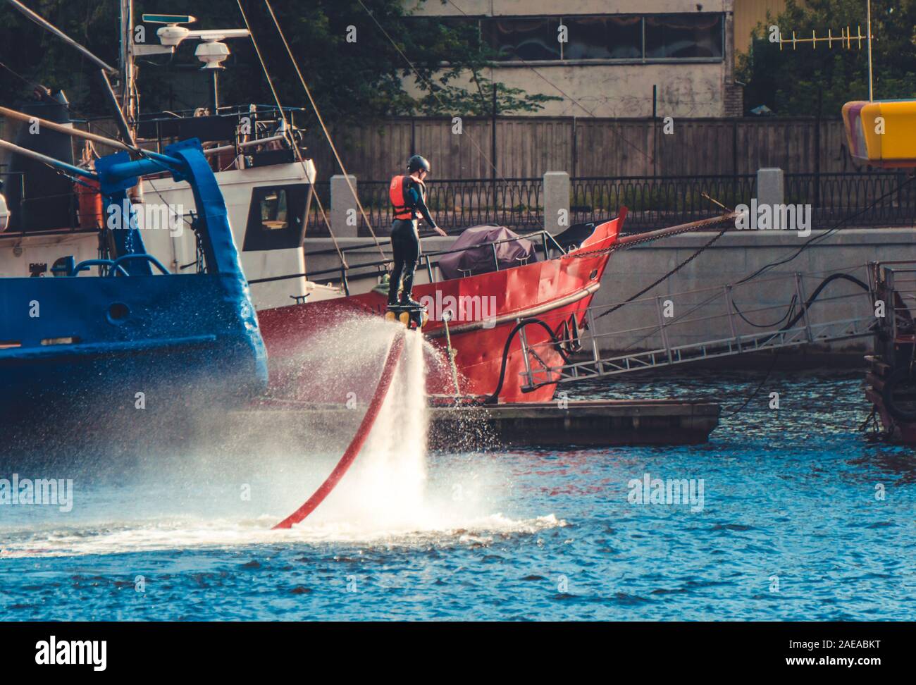 Young woman on fly board over Neva river near port Stock Photo - Alamy