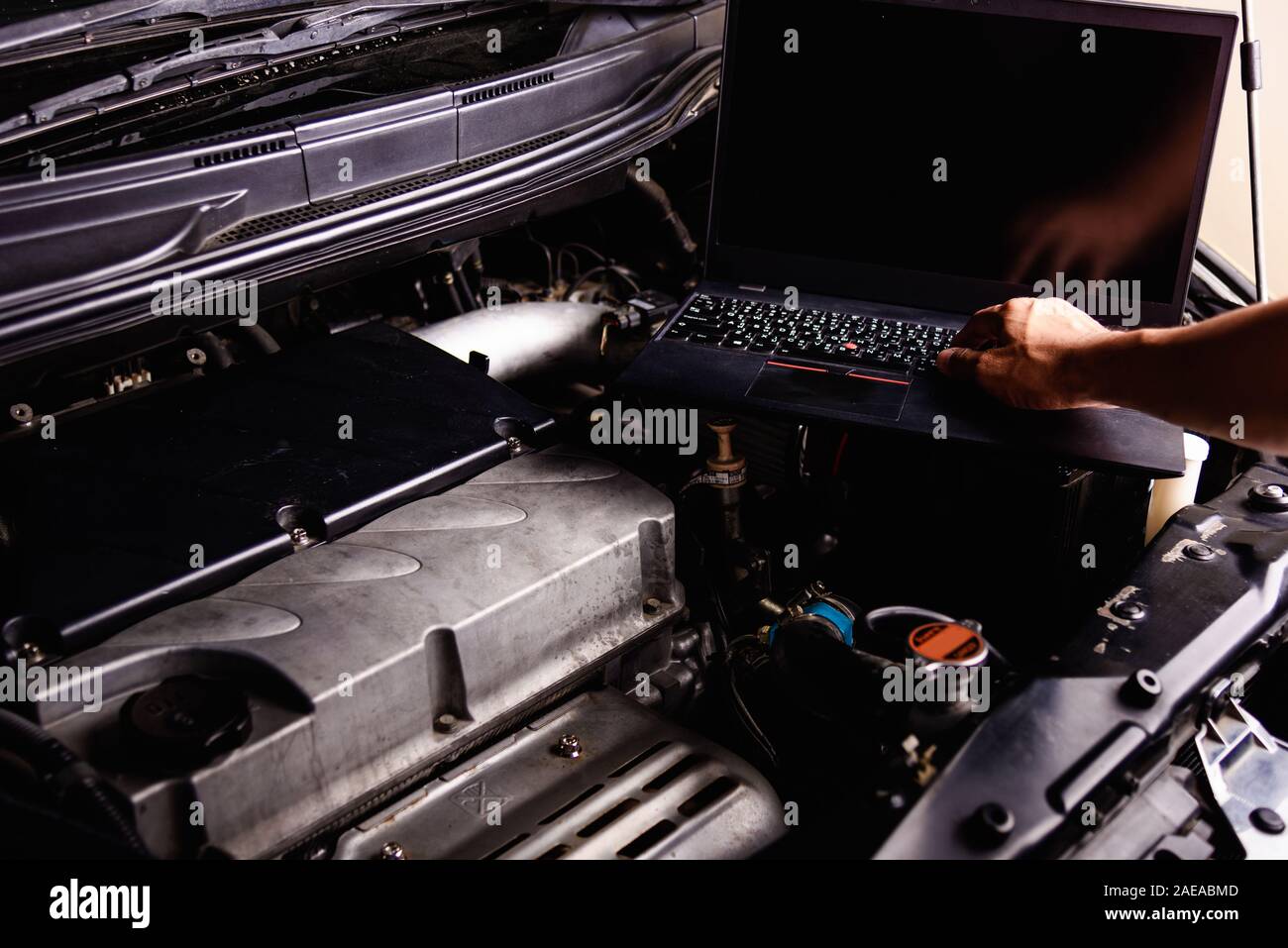 Laptop computer on car mechanic engine for service at workshop Stock ...