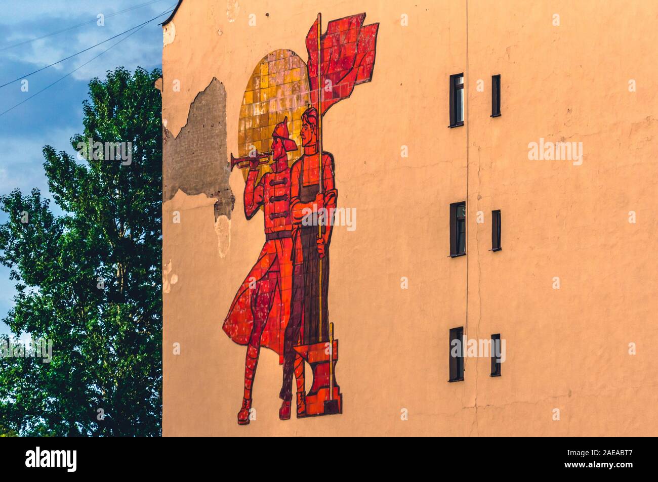 Soviet street art on surface of big building wall. Red communistic ...