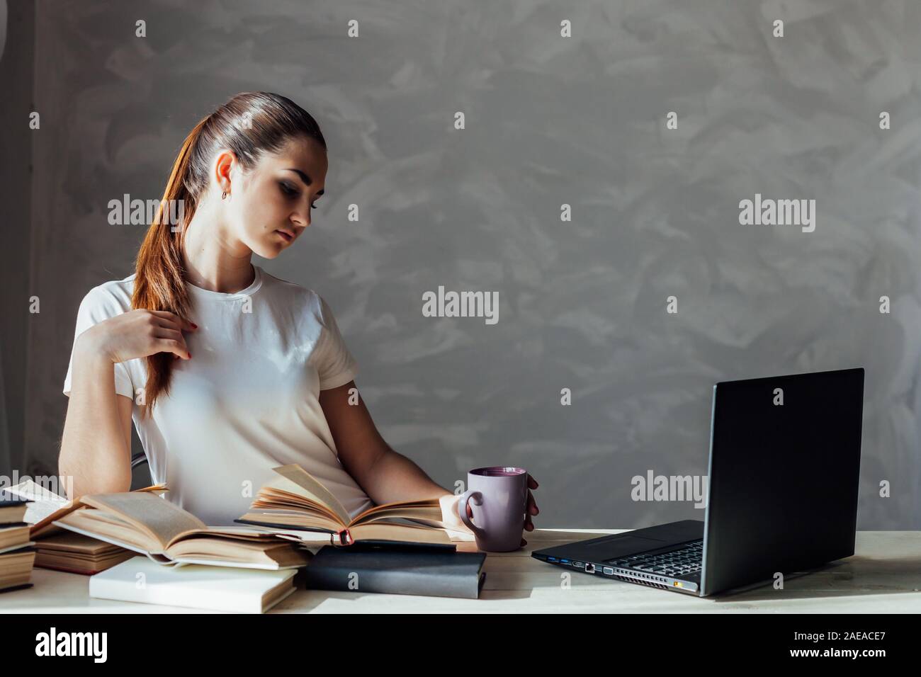 girl reading a book and drinking coffee Stock Photo - Alamy