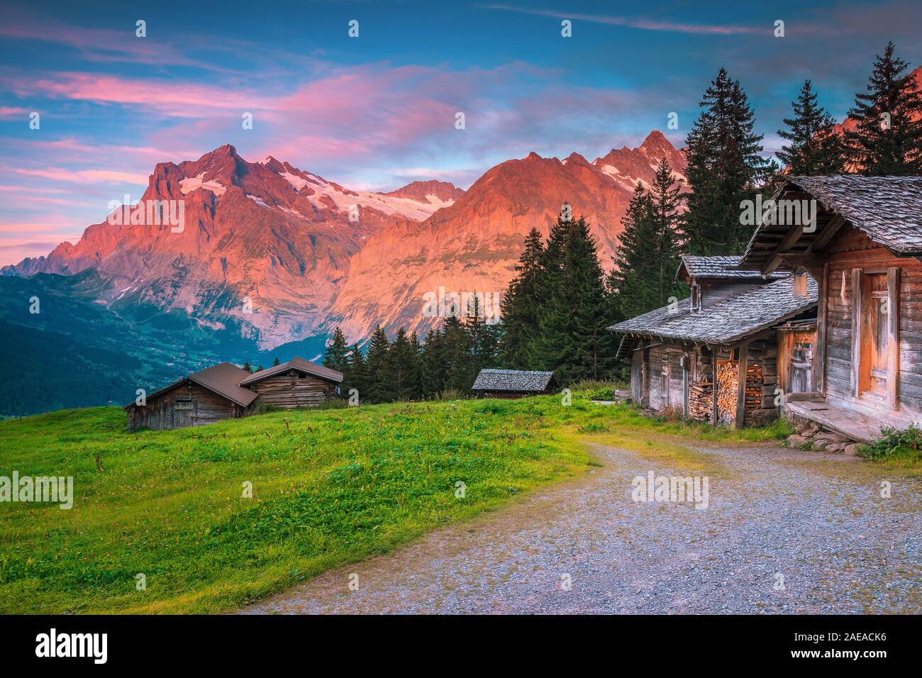 Spectacular summer alpine countryside with old chalets and snowy ...