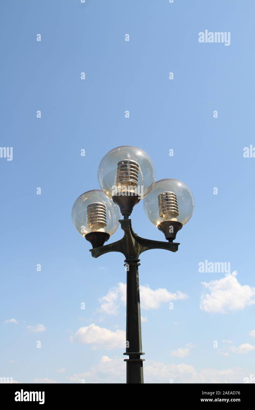 a beautiful old three-lamp street lamp Stock Photo - Alamy
