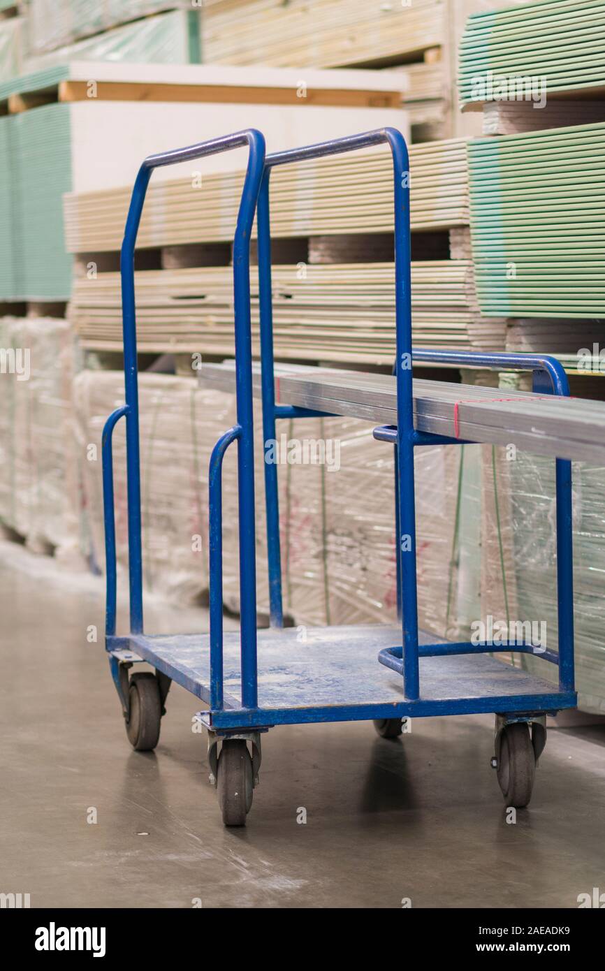 Trolley in a hardware store loaded with construction materials. Repair ...