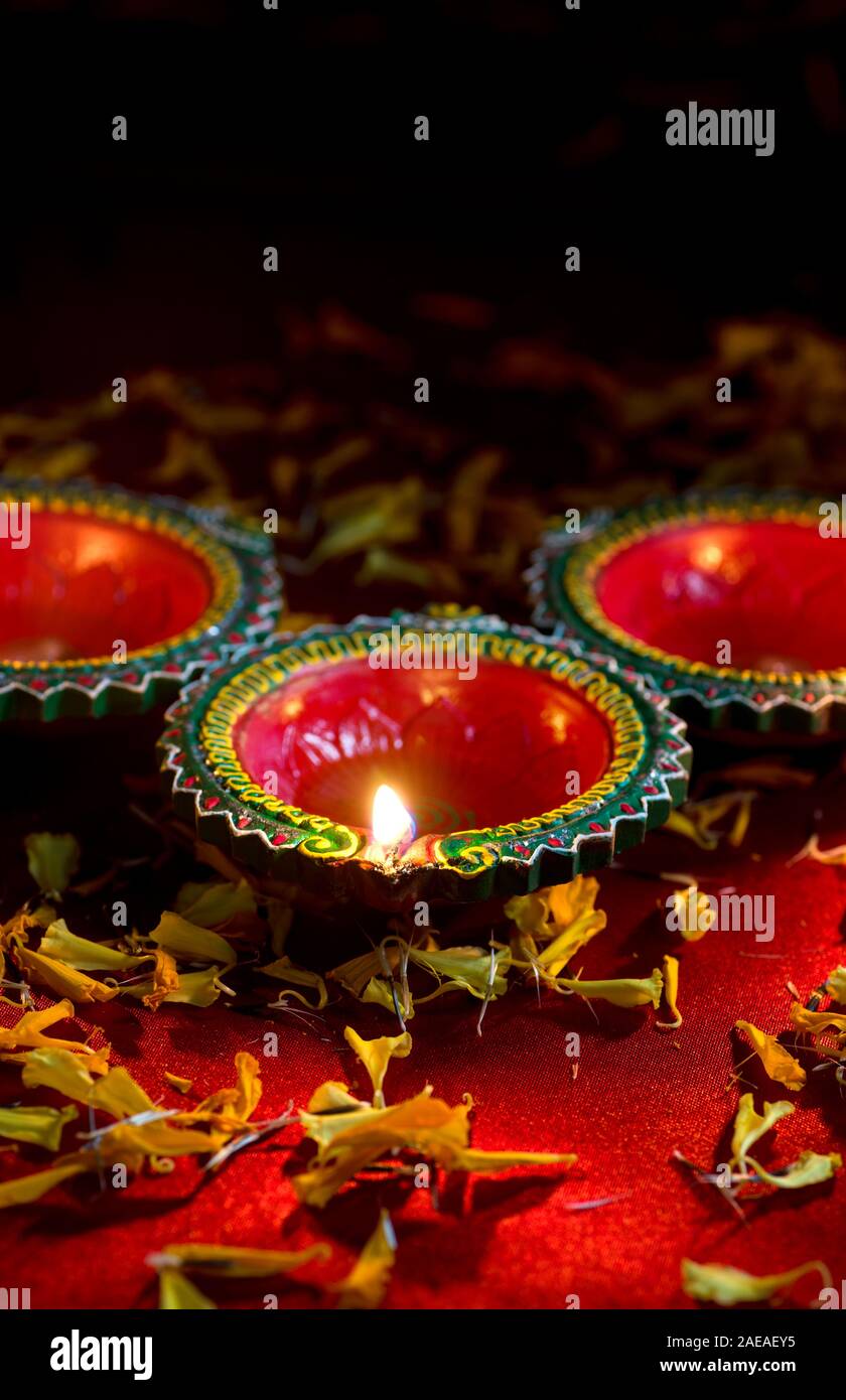 Happy Diwali - Clay Diya lamps lit during Diwali celebration. Greetings ...