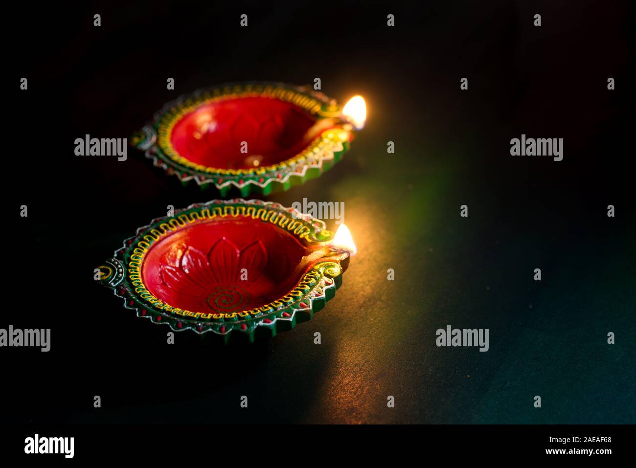 Happy Diwali - Clay Diya lamps lit during Diwali celebration. Greetings ...