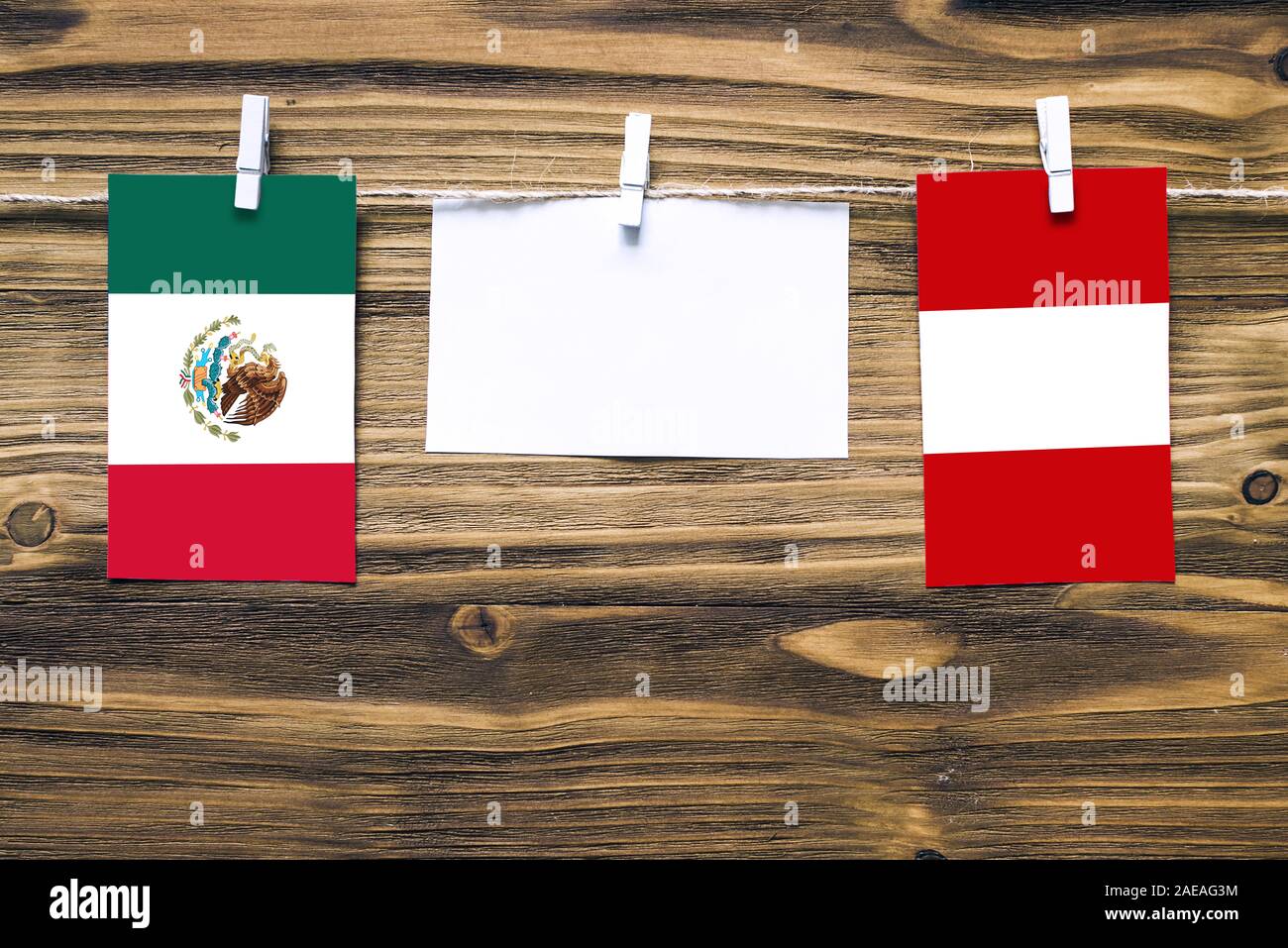 Hanging flags of Mexico and Peru attached to rope with clothes pins ...