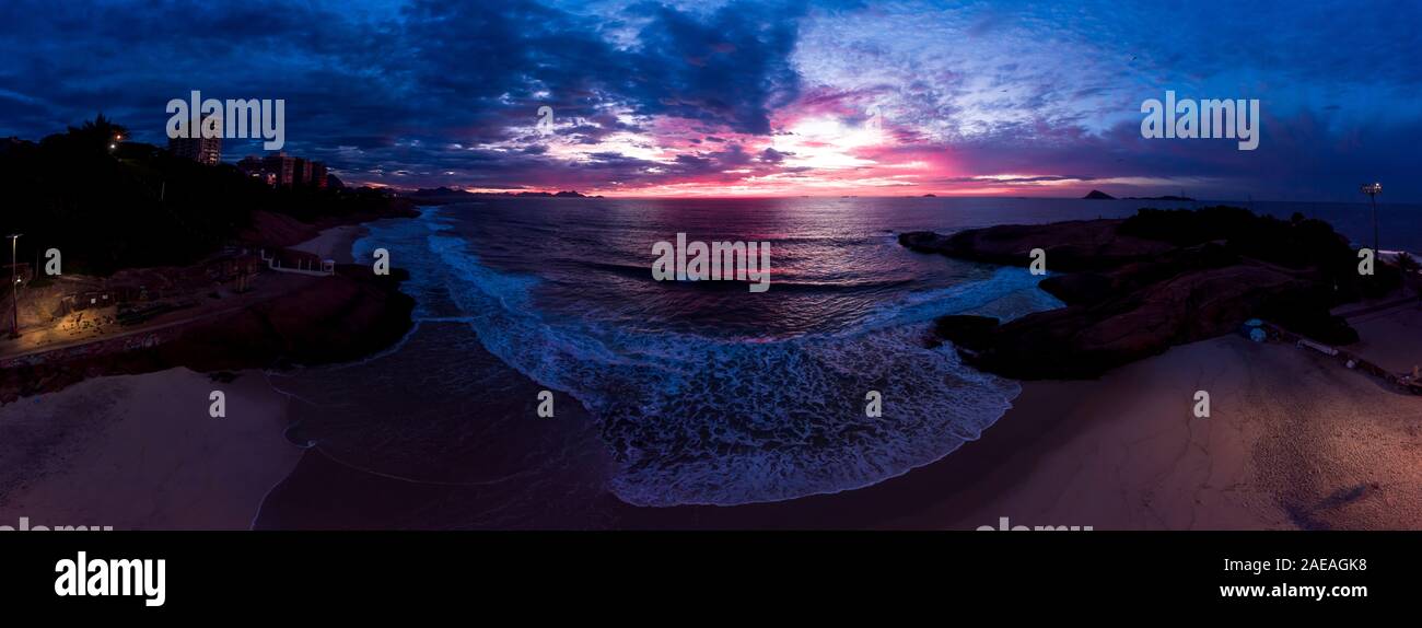 Wide distorted aerial panorama with colourful crack of dawn just before ...