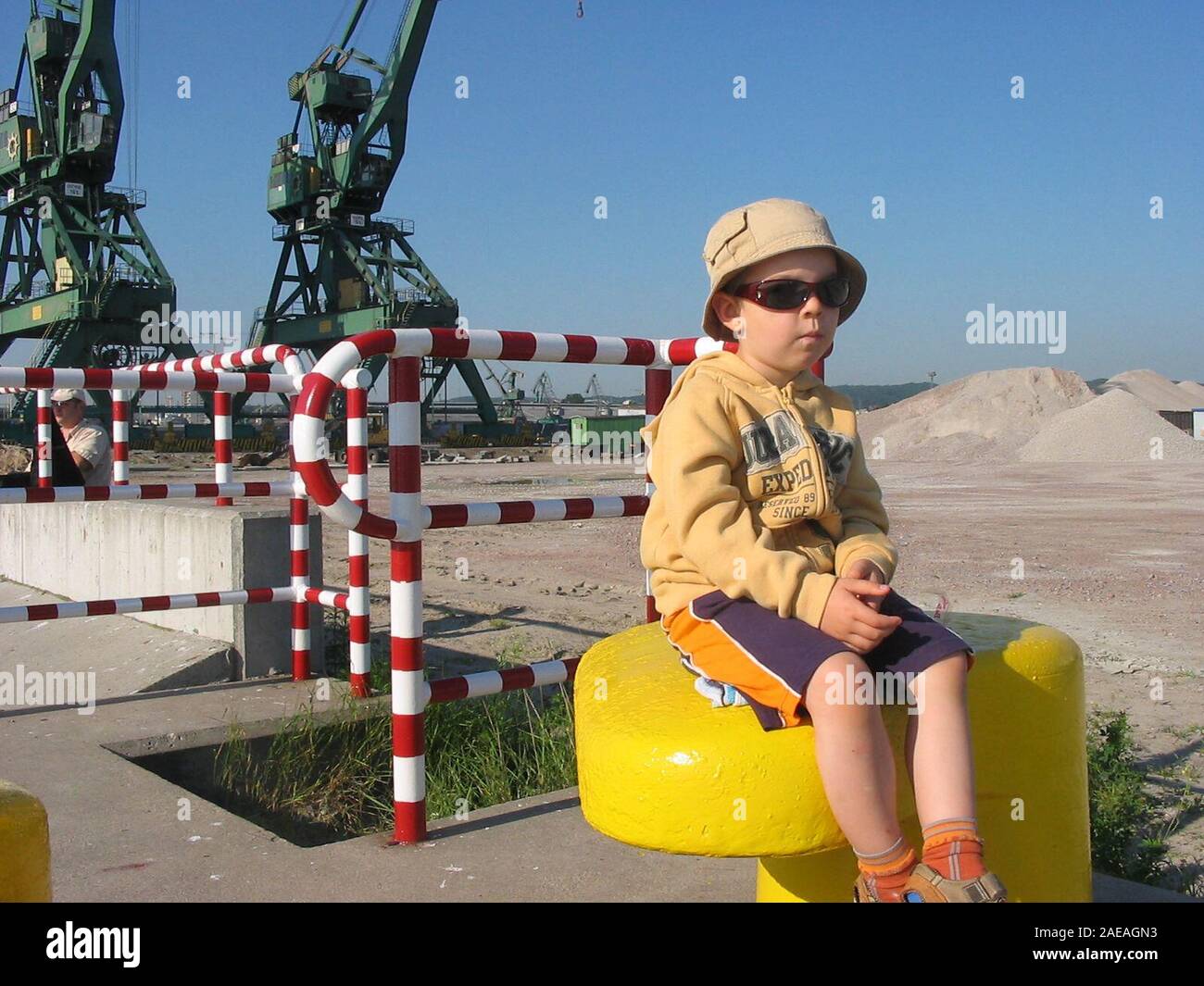 Child, little boy in a harbor, by a bollard Stock Photo - Alamy
