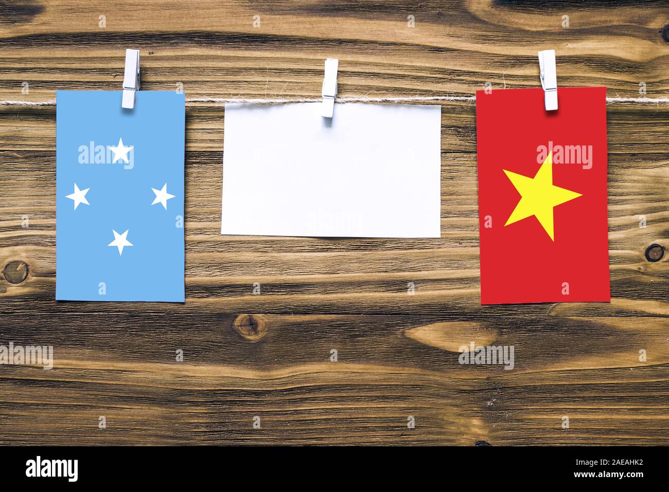 Hanging flags of Micronesia and Vietnam attached to rope with clothes ...