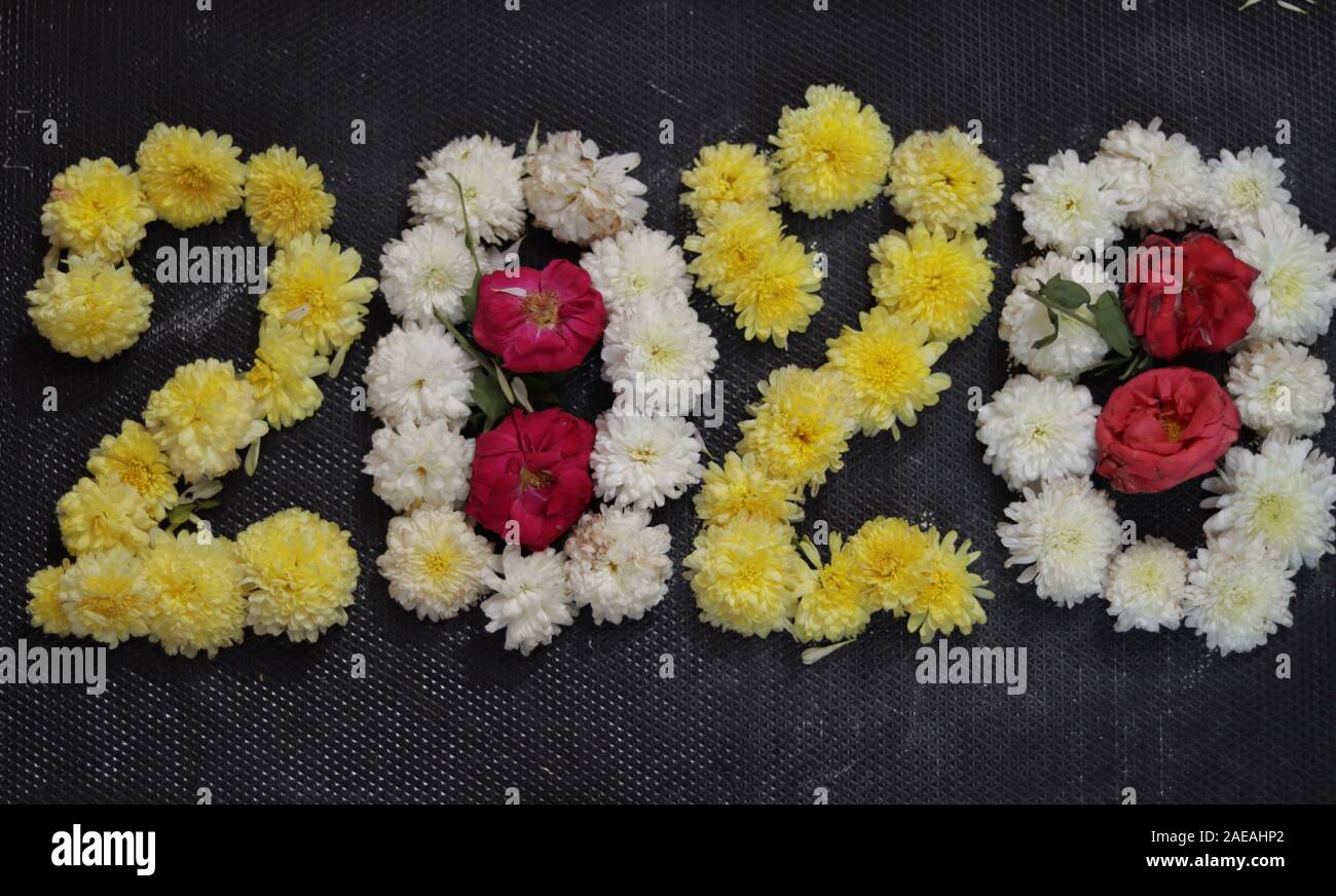 create 2020 with flowers on black background Stock Photo - Alamy