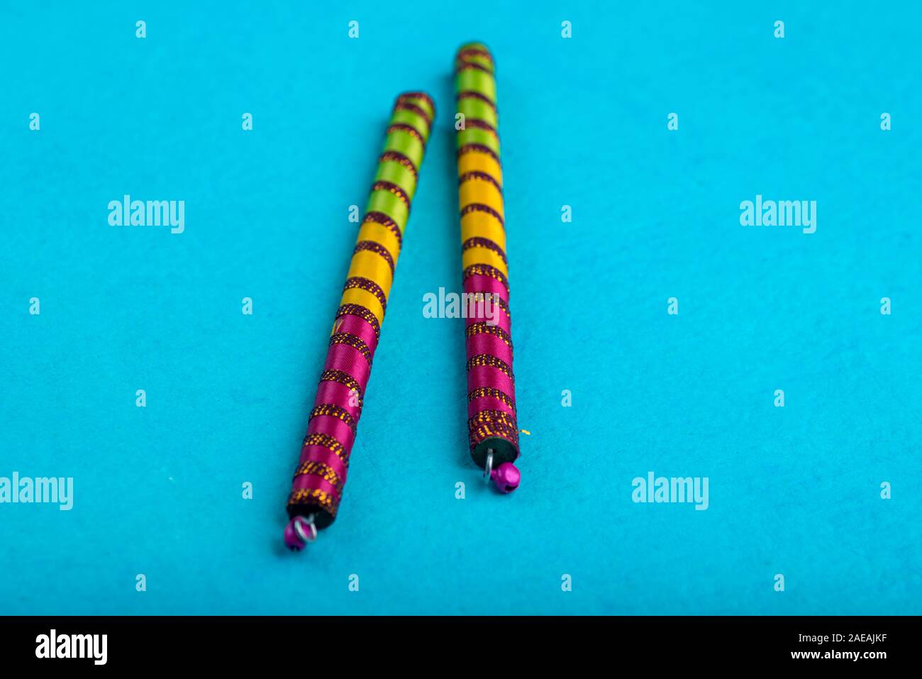 Dandiya sticks on a blue background. Raas Garba or Dandiya Raas is the ...