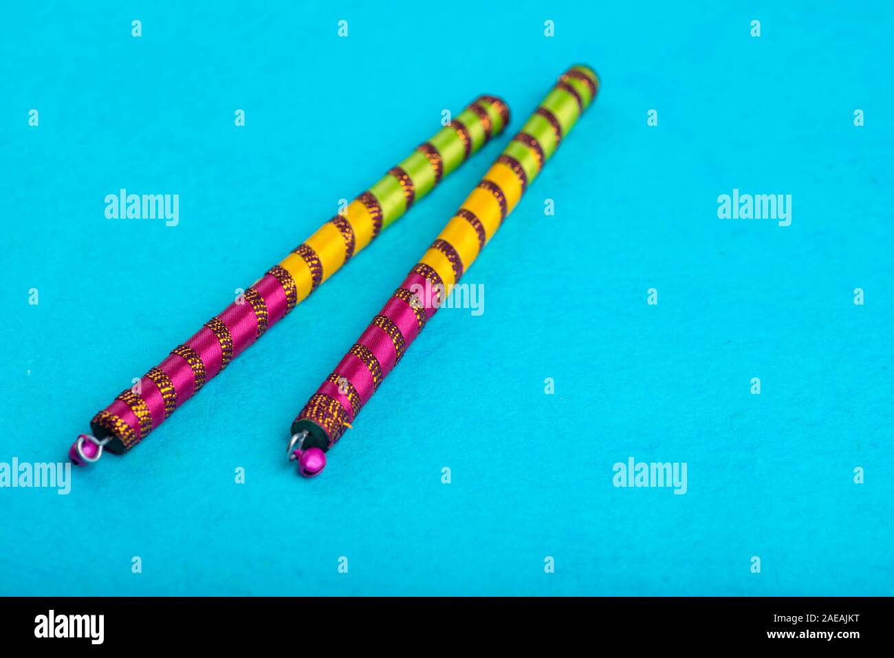 Dandiya sticks on a blue background. Raas Garba or Dandiya Raas is the ...