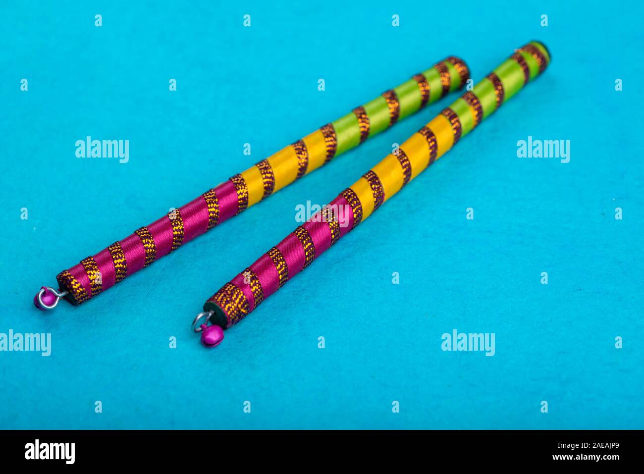 Dandiya sticks on a blue background. Raas Garba or Dandiya Raas is the ...