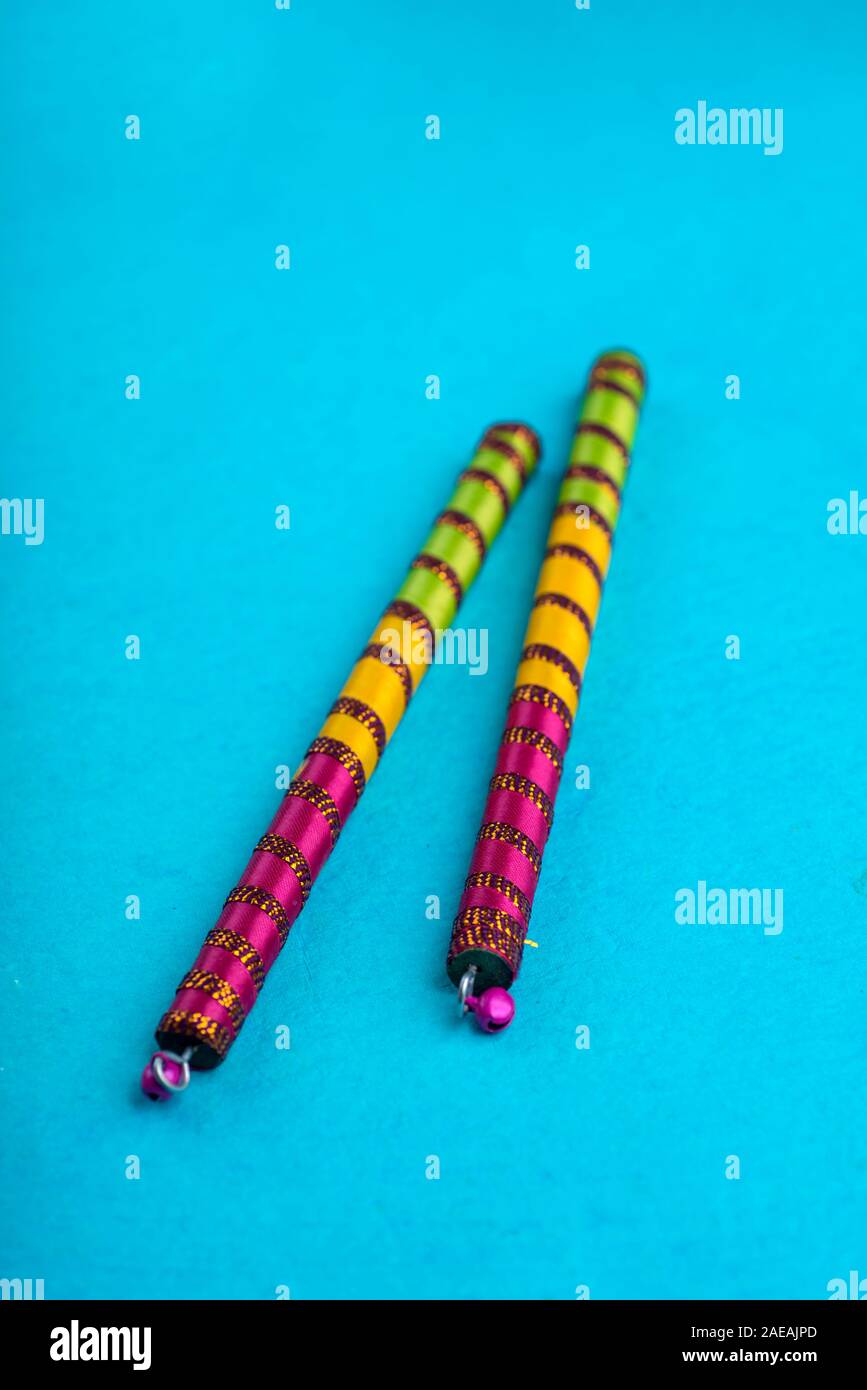 Dandiya sticks on a blue background. Raas Garba or Dandiya Raas is the ...