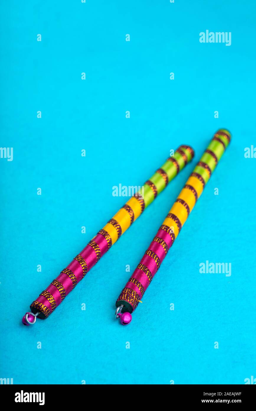 Dandiya sticks on a blue background. Raas Garba or Dandiya Raas is the ...