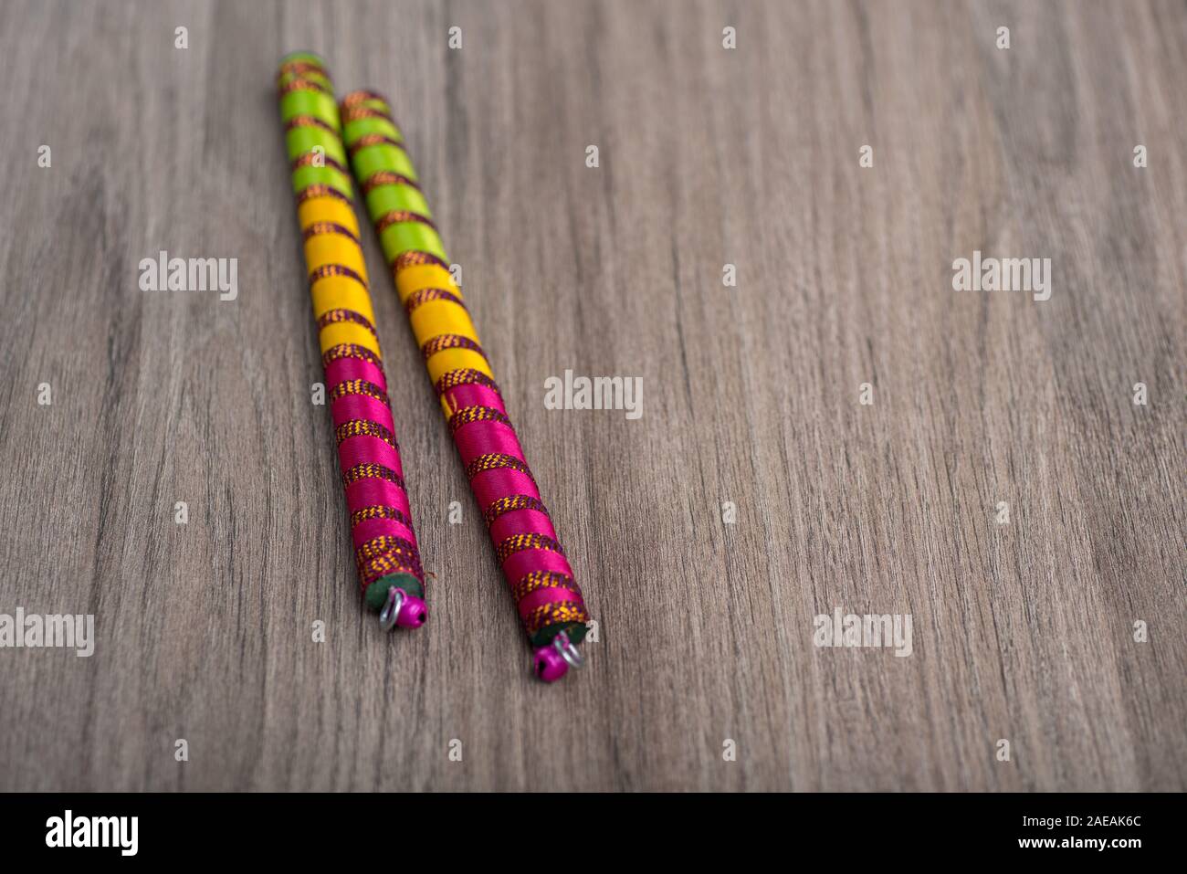 Dandiya sticks on a wooden background. Raas Garba or Dandiya Raas is ...