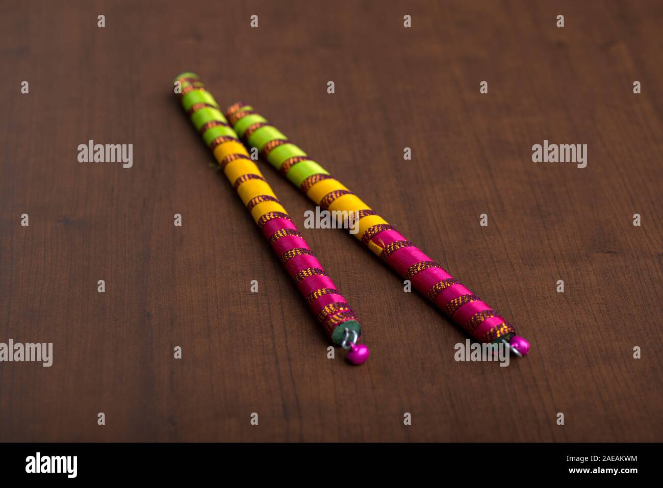Dandiya sticks on a brown background. Raas Garba or Dandiya Raas is the ...