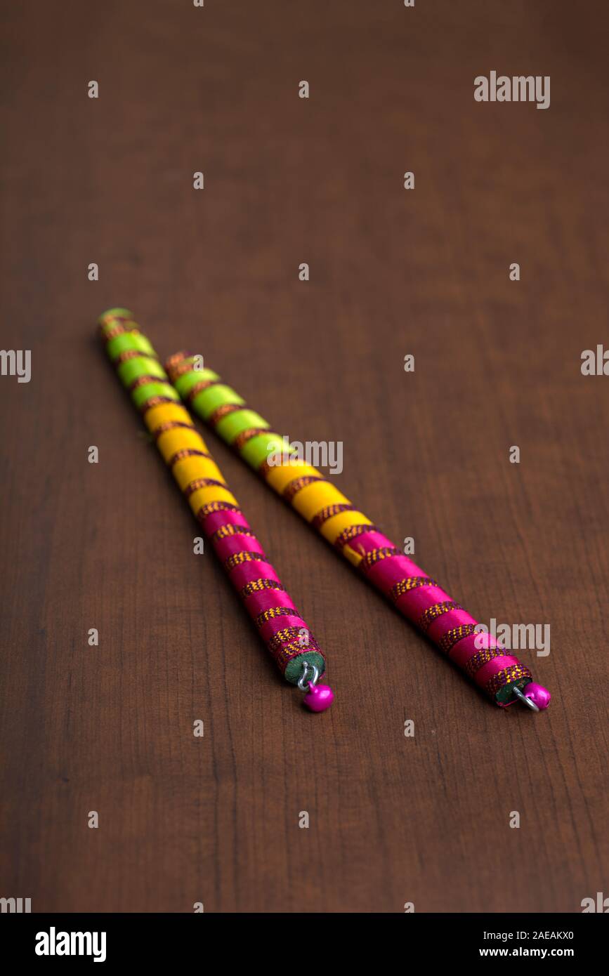 Dandiya sticks on a brown background. Raas Garba or Dandiya Raas is the ...