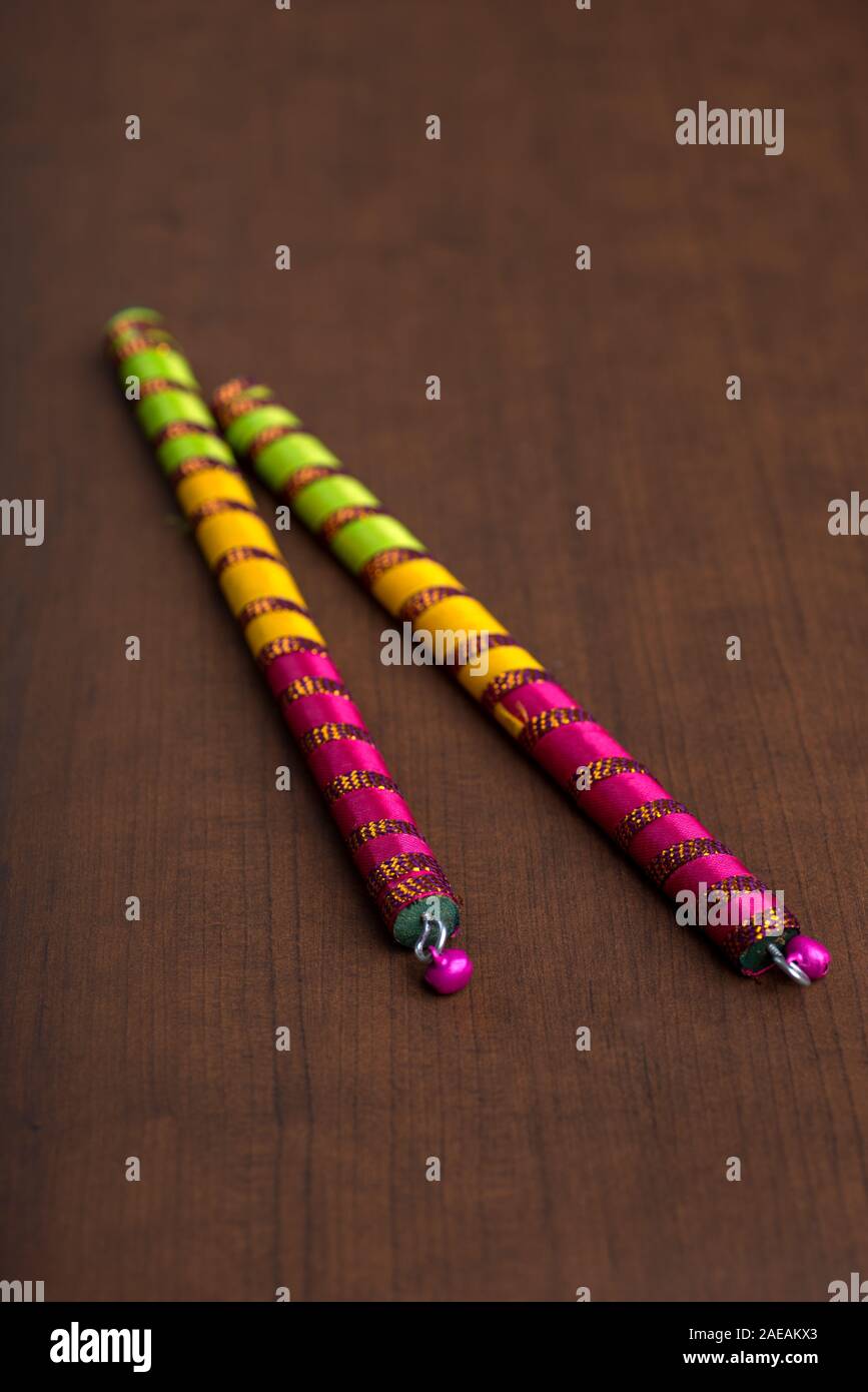 Dandiya sticks on a brown background. Raas Garba or Dandiya Raas is the ...