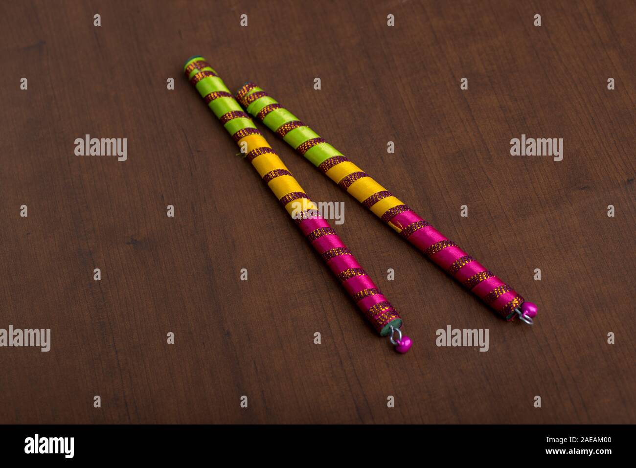 Dandiya sticks on a brown background. Raas Garba or Dandiya Raas is the ...