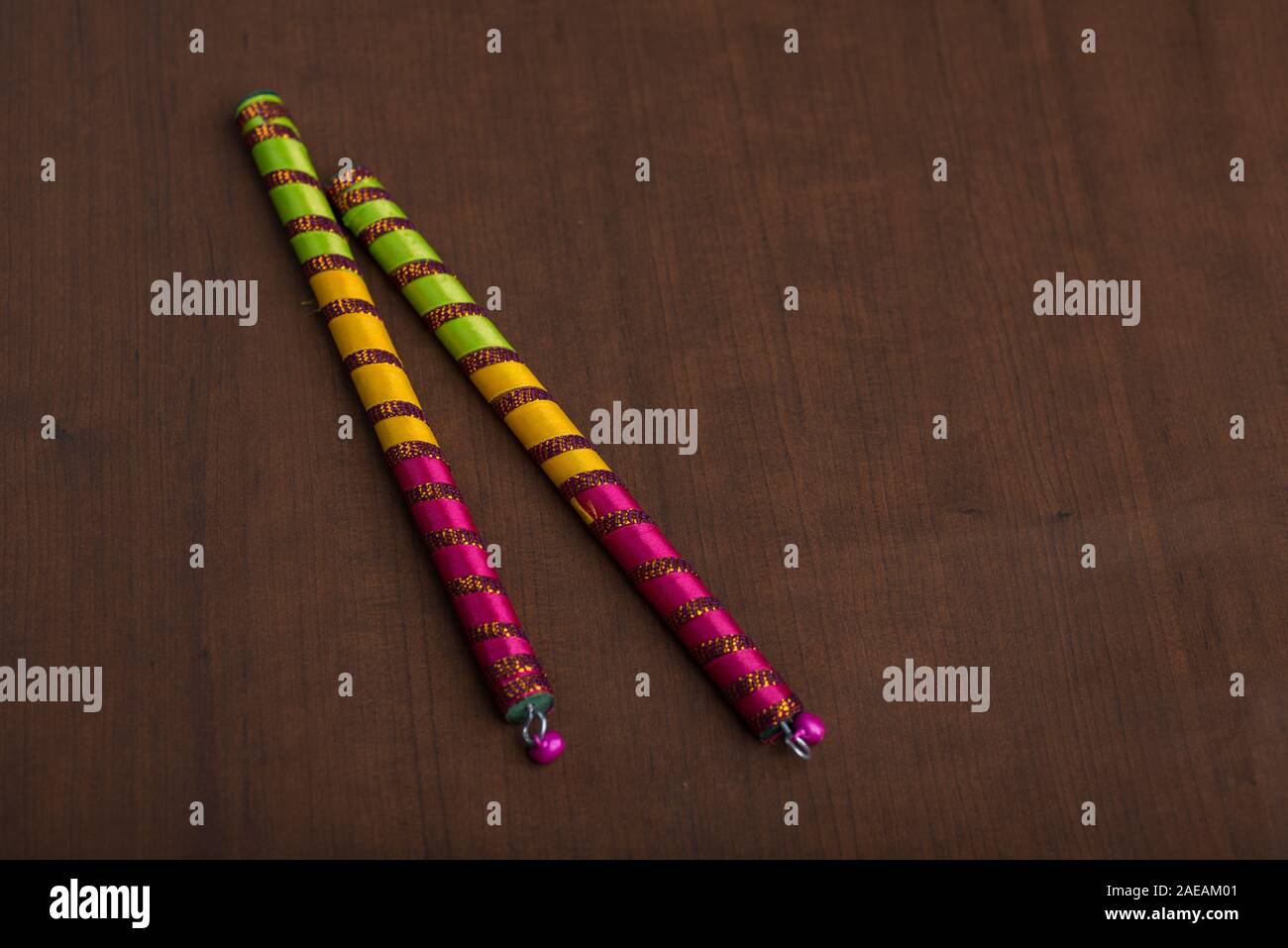 Dandiya sticks on a brown background. Raas Garba or Dandiya Raas is the ...