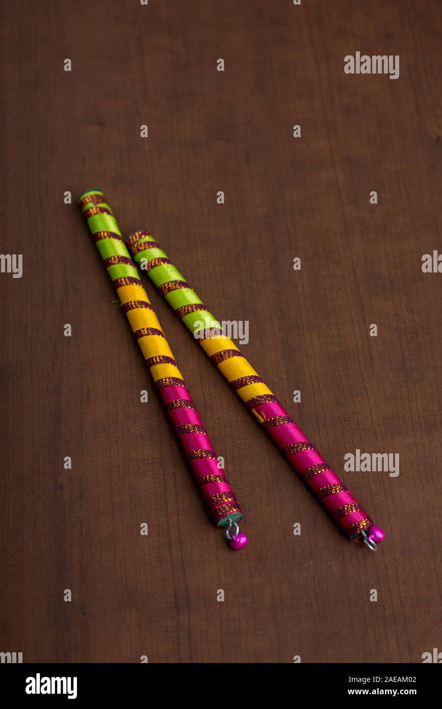 Dandiya sticks on a brown background. Raas Garba or Dandiya Raas is the ...