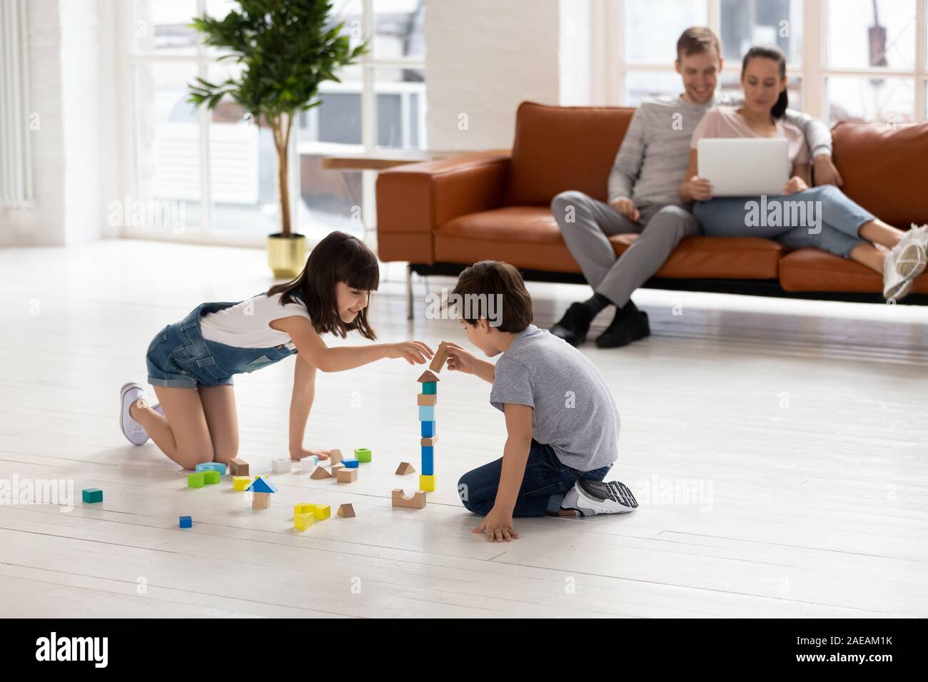 Happy brother and sister building constructor tower Stock Photo - Alamy