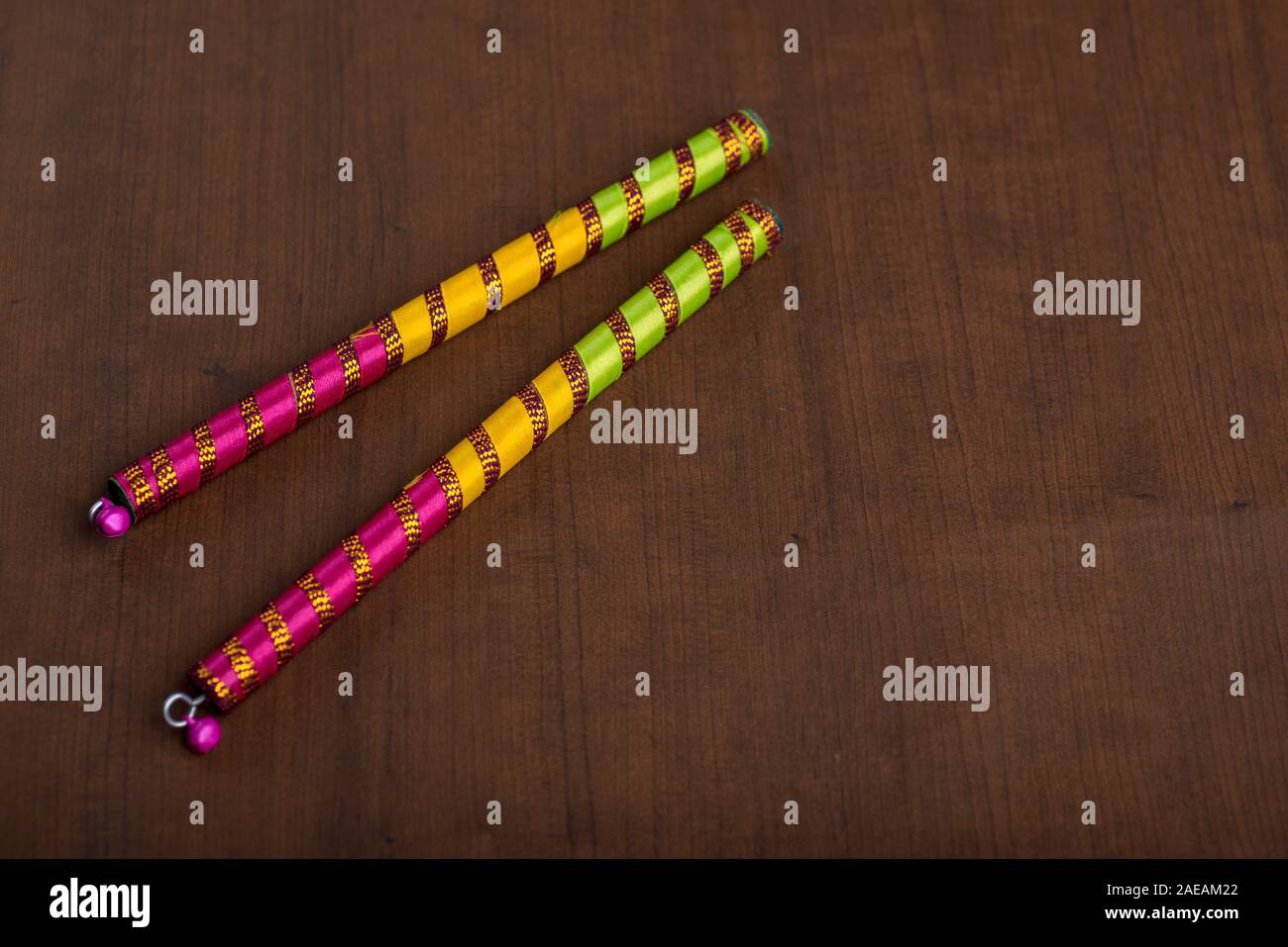 Dandiya sticks on a brown background. Raas Garba or Dandiya Raas is the ...