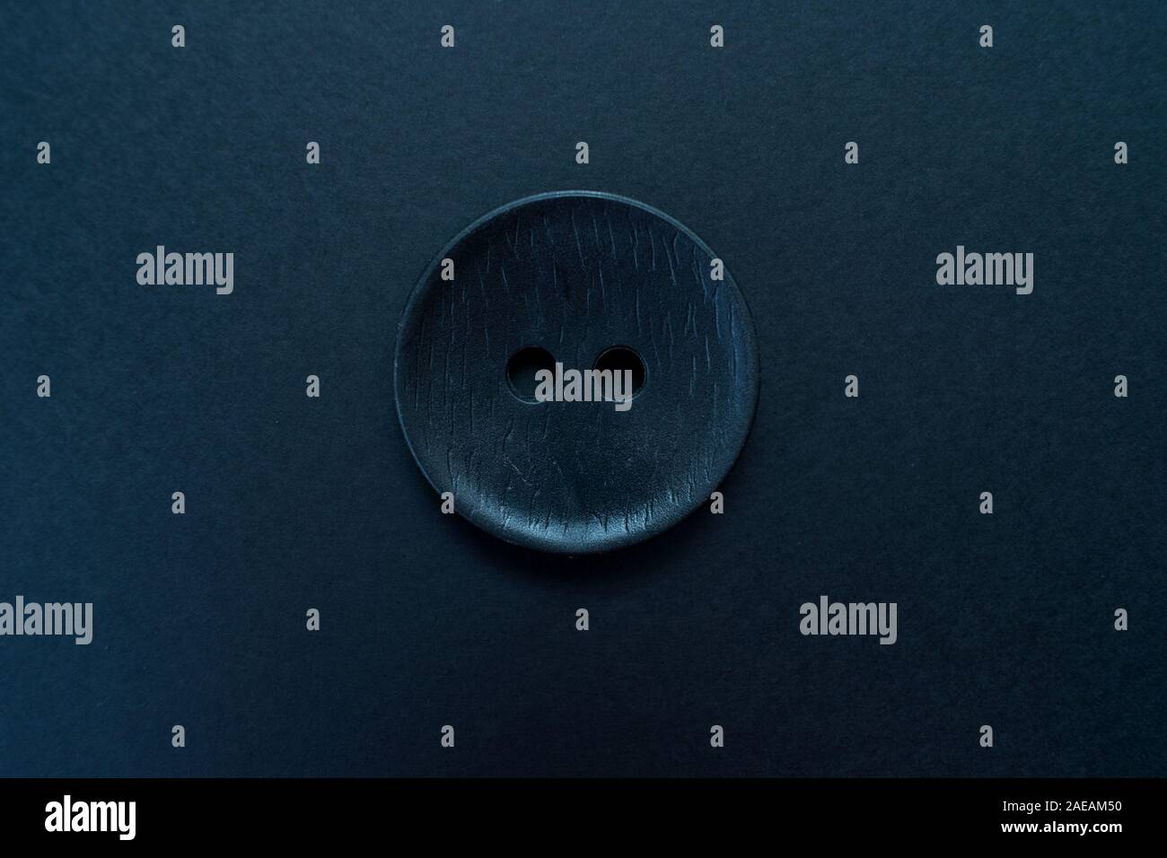Big black button isolated on a black background Stock Photo - Alamy