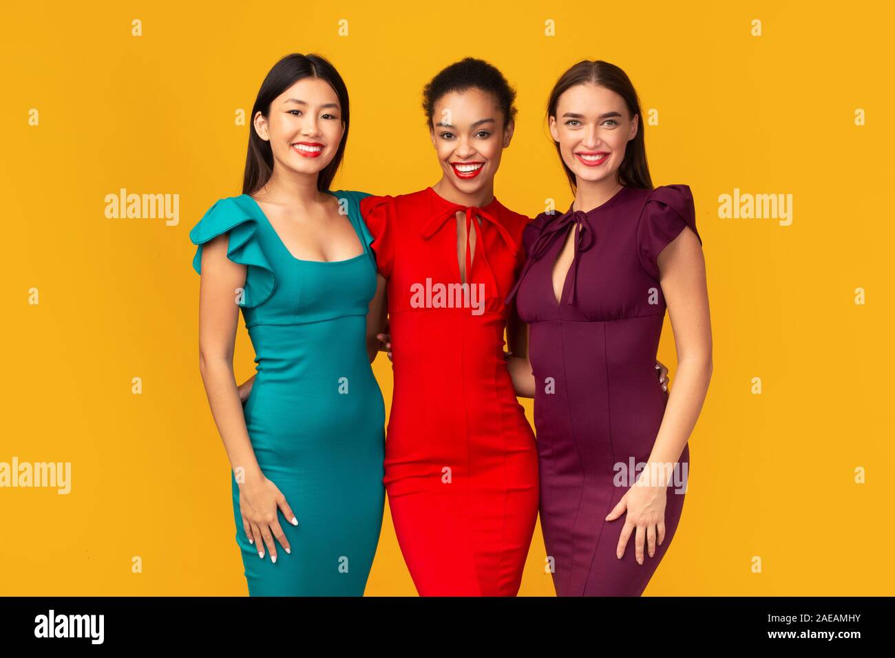Three Diverse Ladies In Dresses Smiling And Hugging, Studio Shot Stock ...