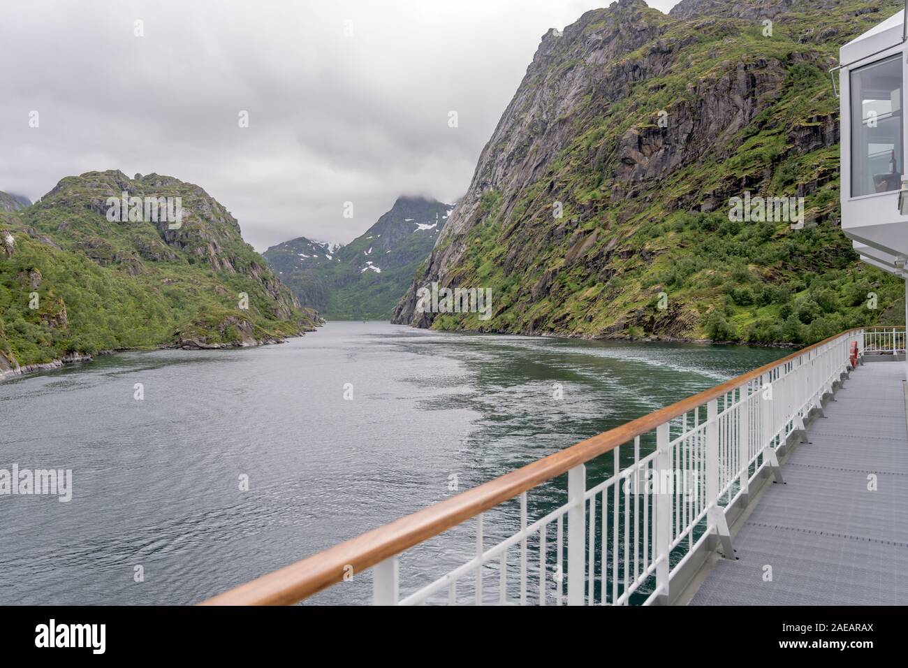 foreshorthening of empty deck of liner going out of narrow fjord, shot ...
