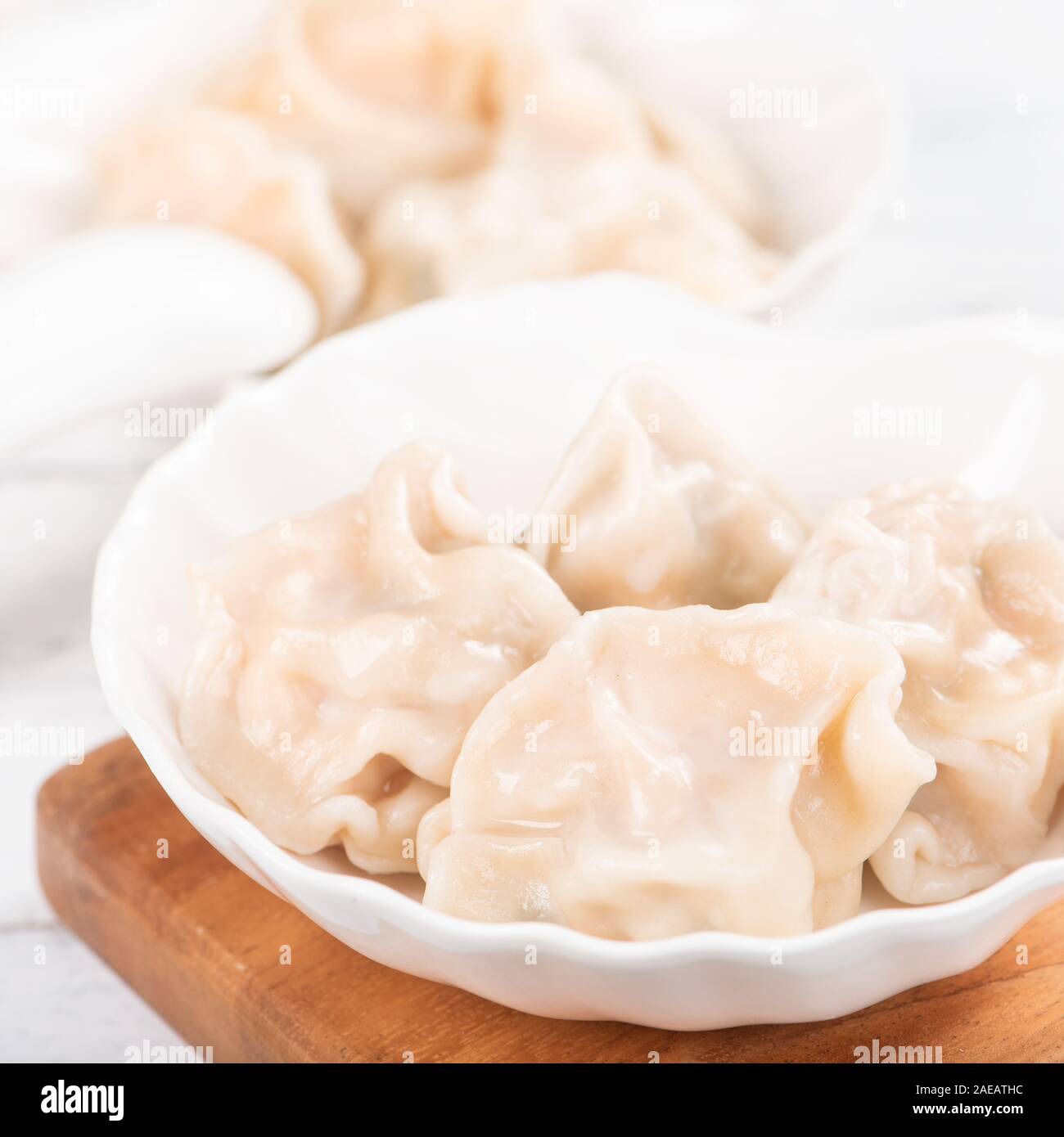 Fresh, delicious boiled pork gyoza dumplings, jiaozi on white ...