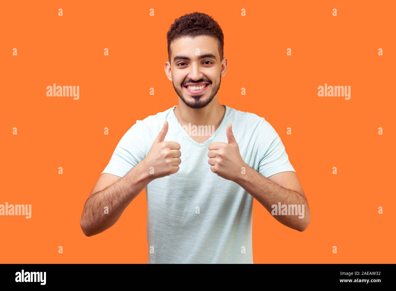 Like! Portrait of optimistic handsome brunette man with beard in white ...